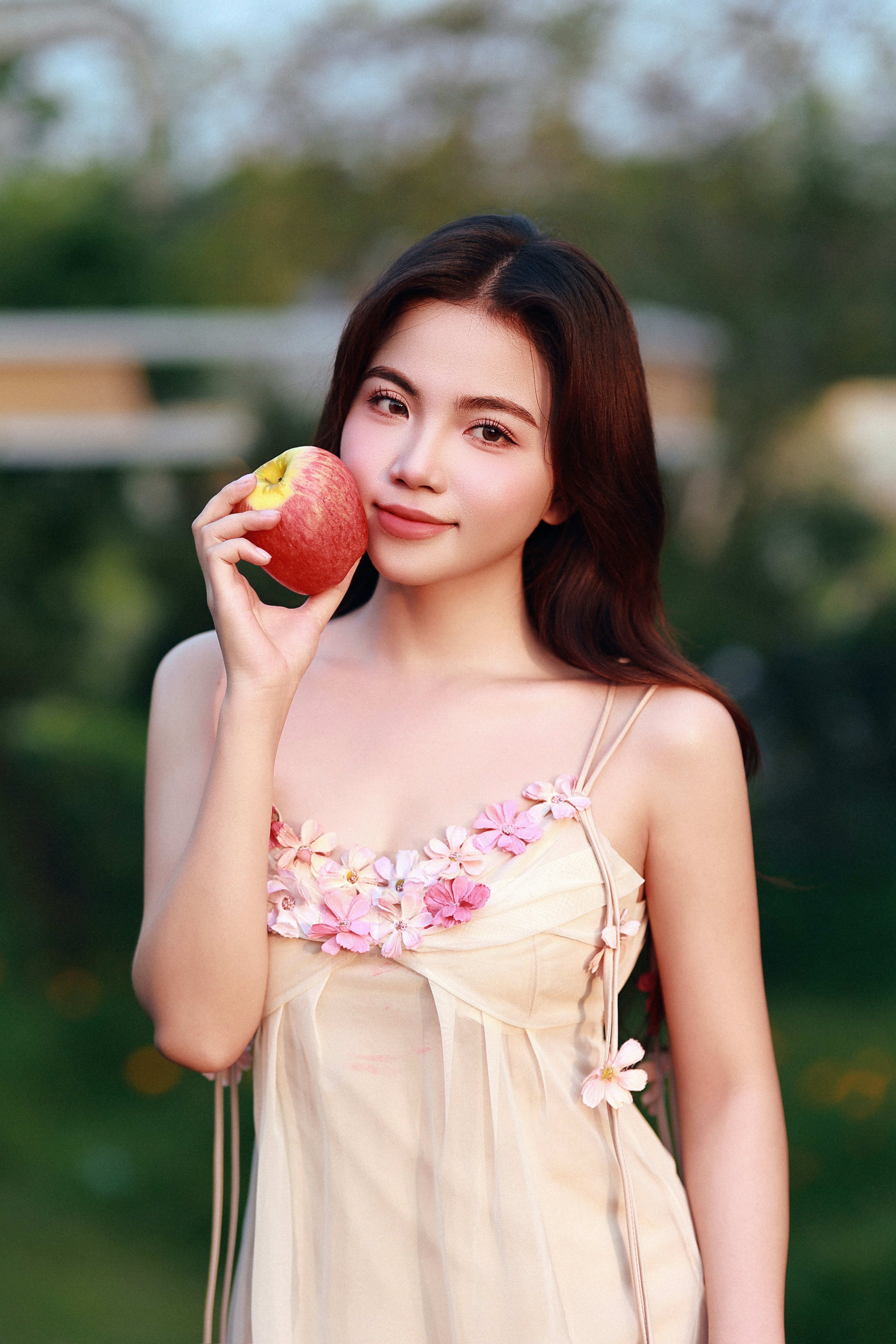 Young woman in a floral dress during golden hour.