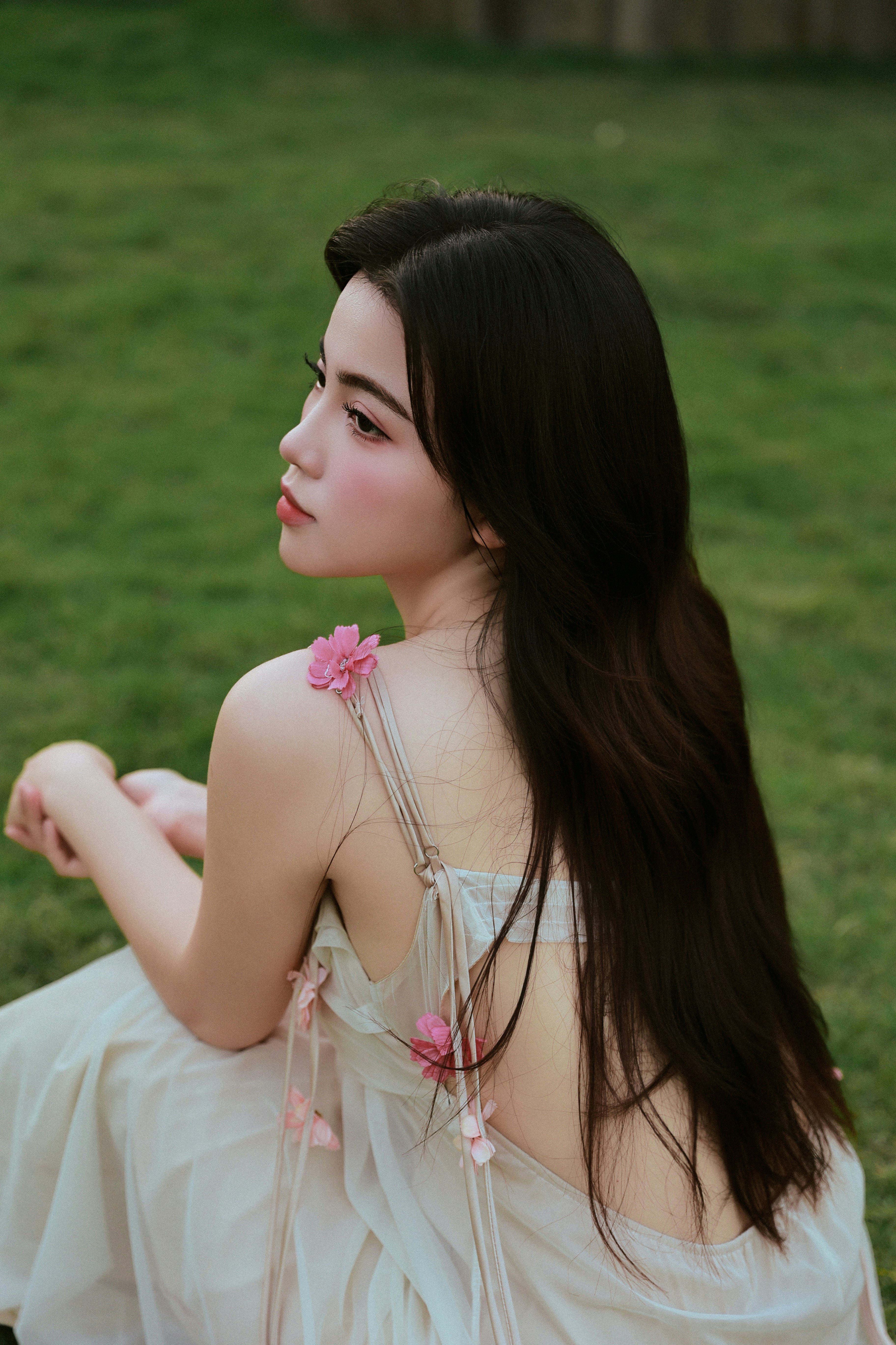 Young woman in a floral dress during golden hour.
