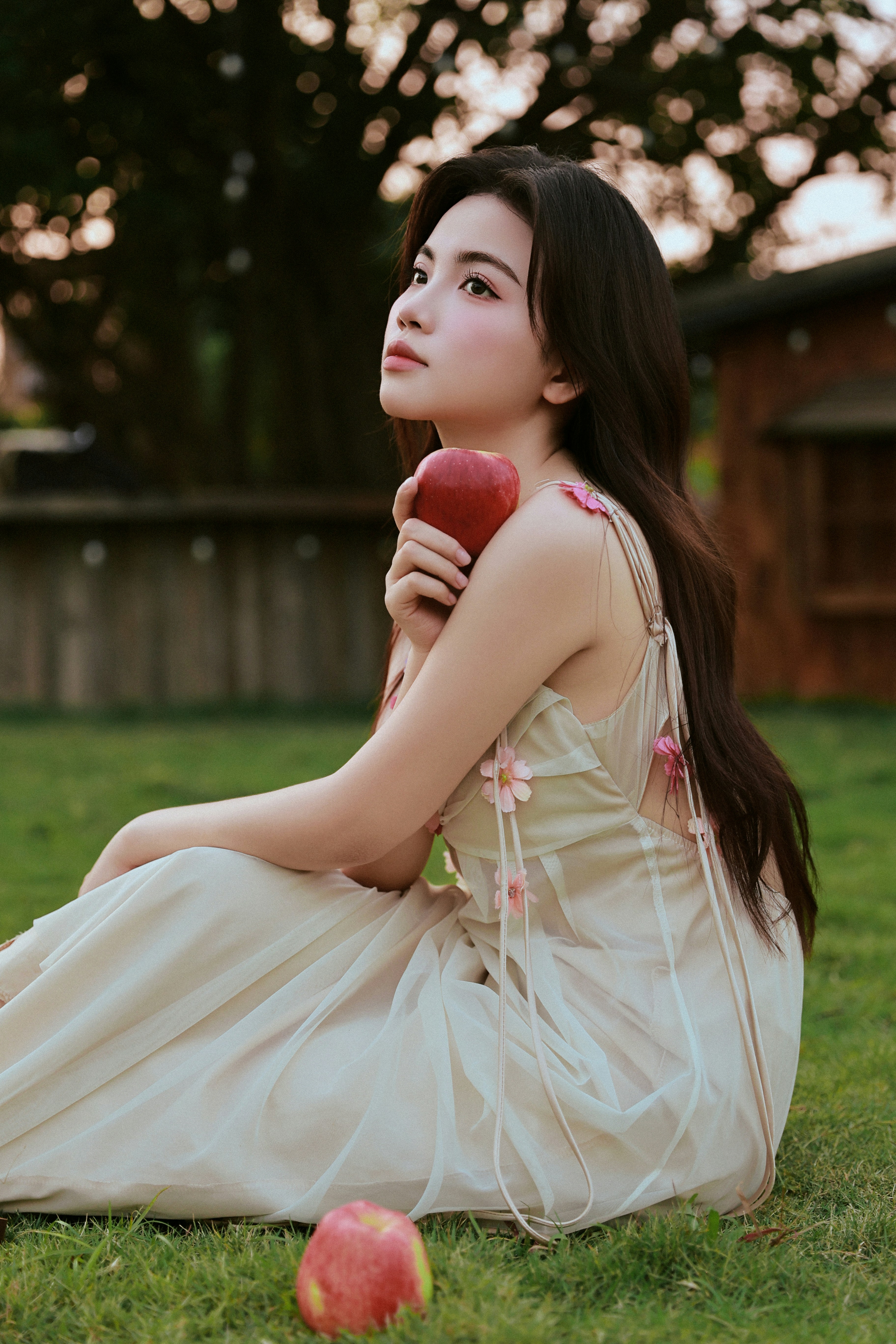 Young woman in a floral dress during golden hour.