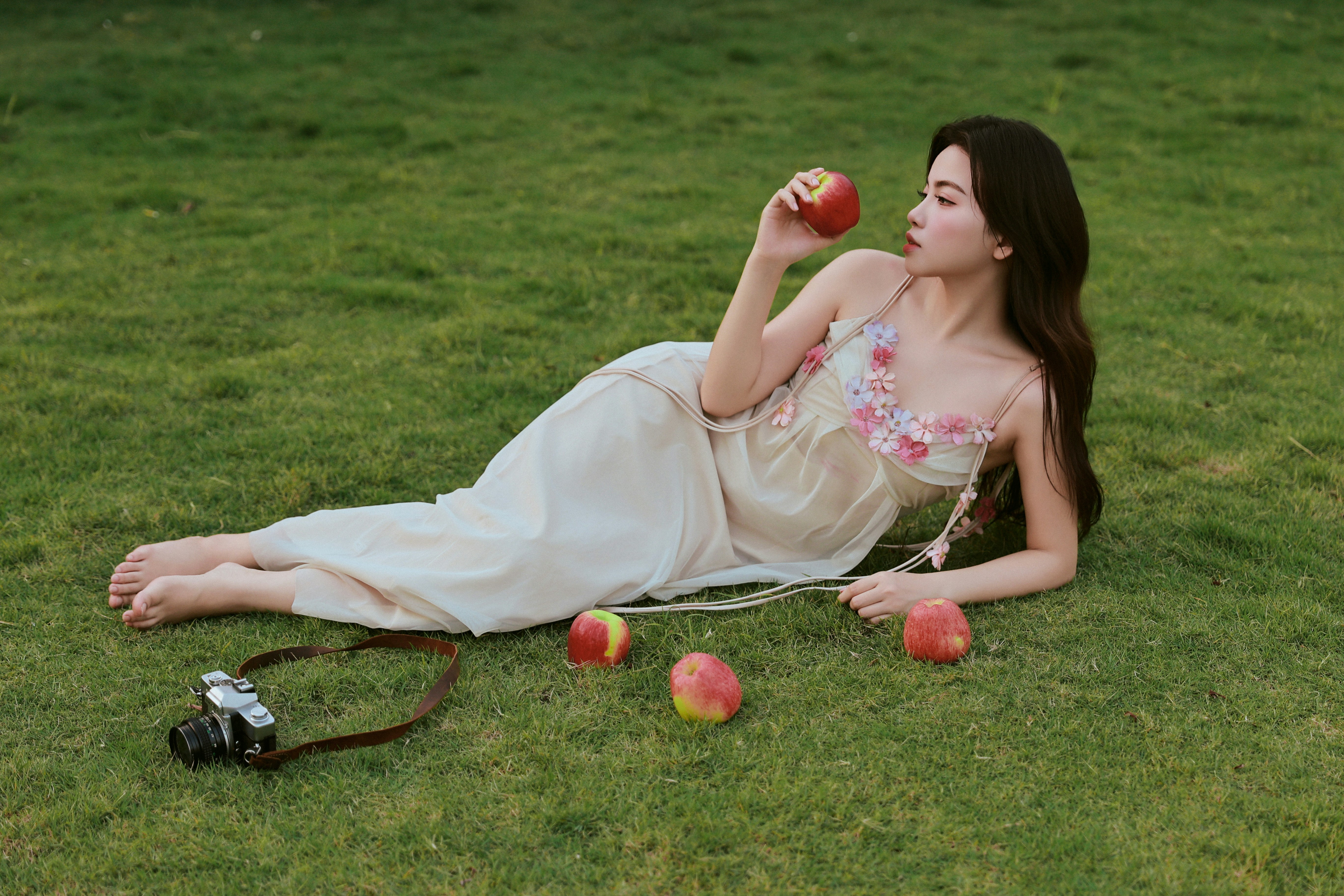 Young woman in a floral dress during golden hour.