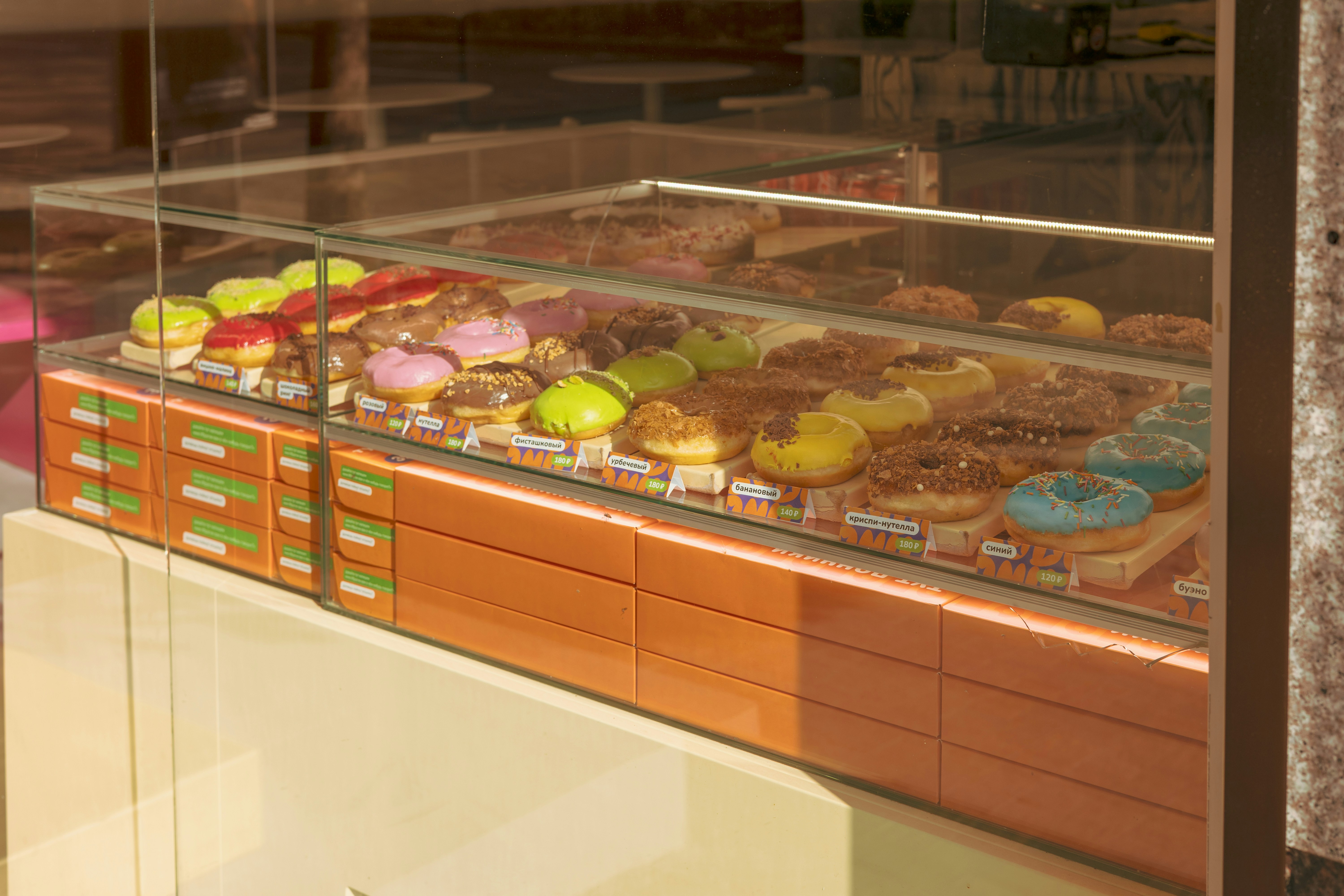 Spectrum of Donuts Under Glass: A Warm Bakery Portrait