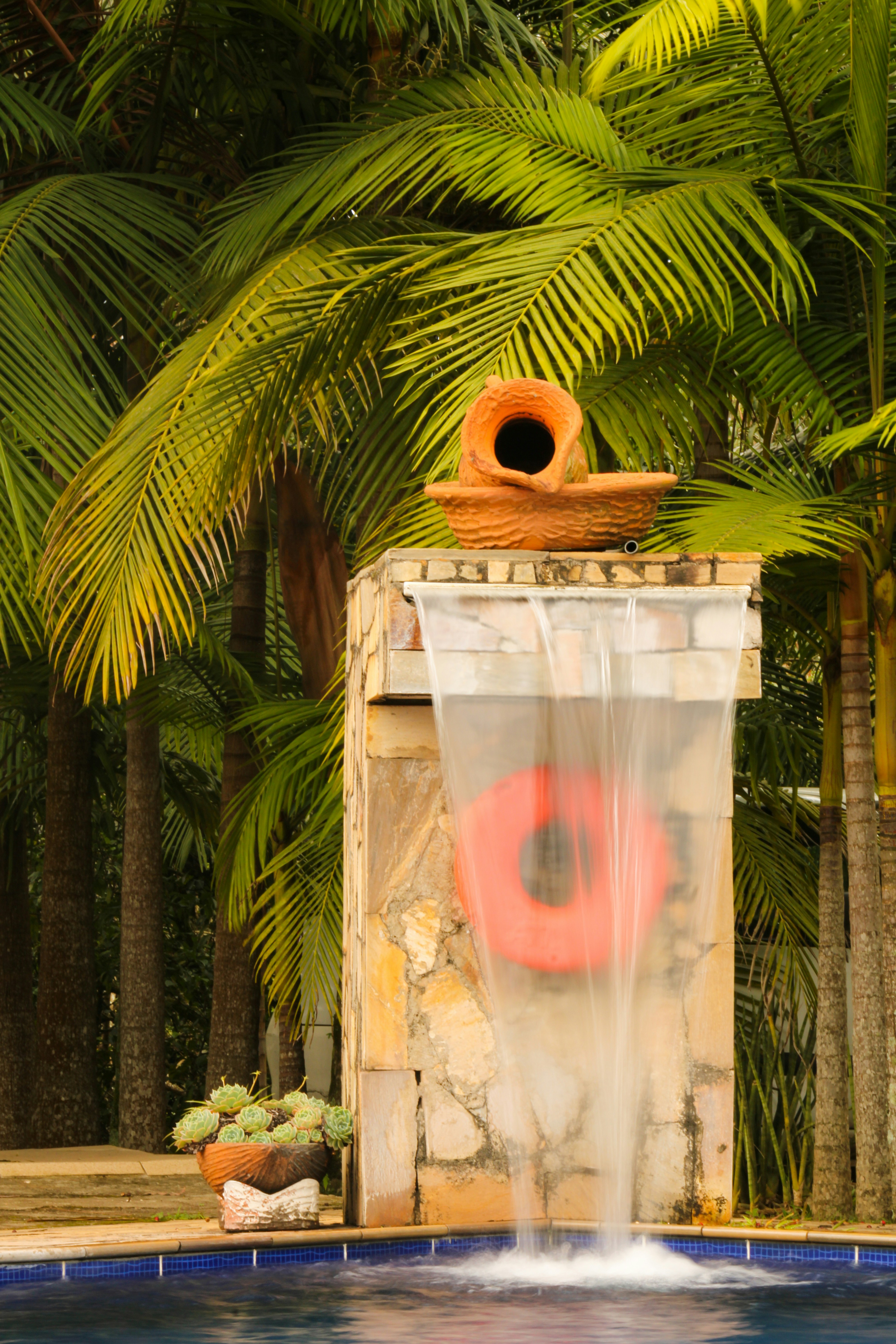 Terracotta Crowned Fountain Framed by Tropical Palms