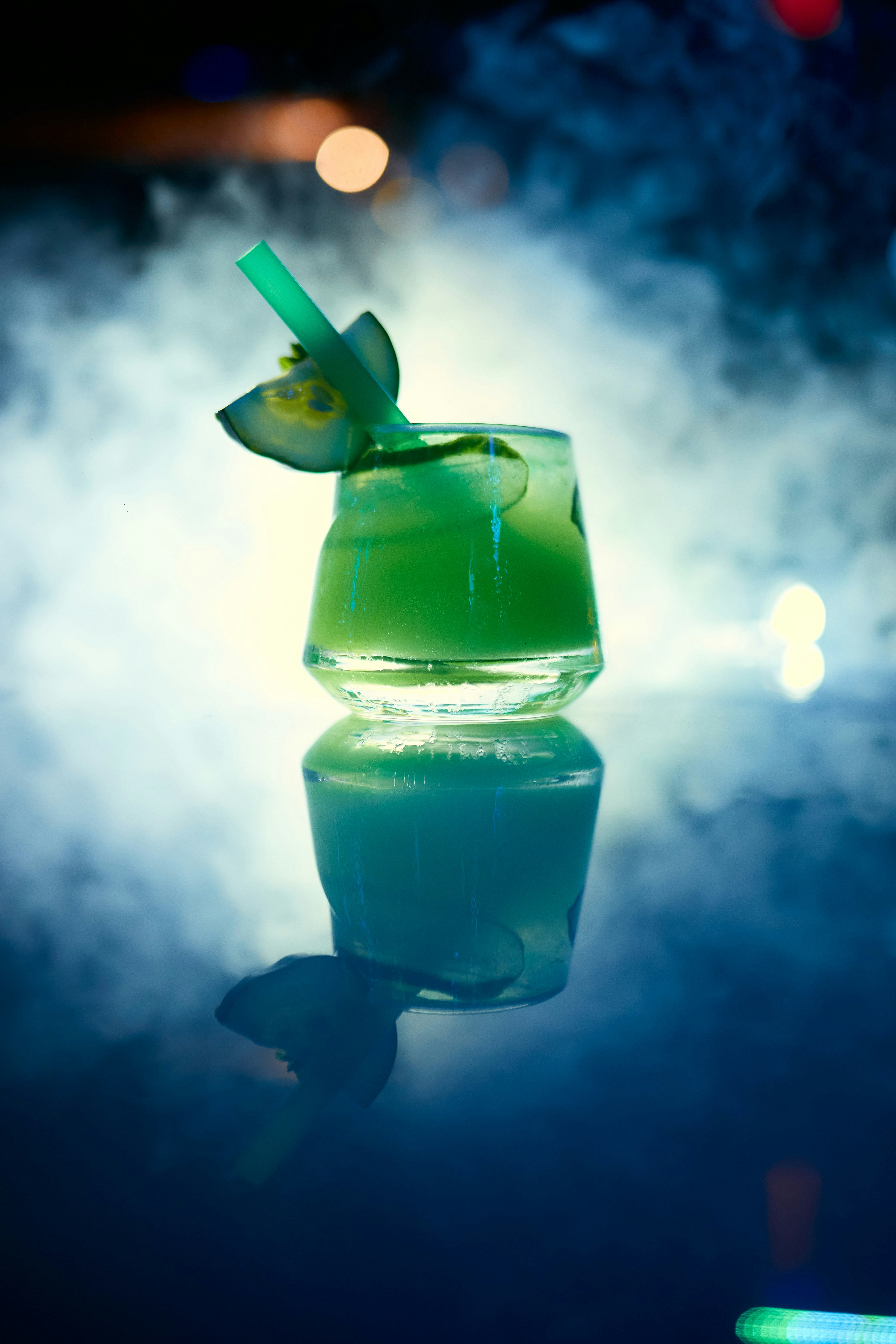 Lime Glow Over Blue Smoke: A Green Cocktail's Mirrored Moment