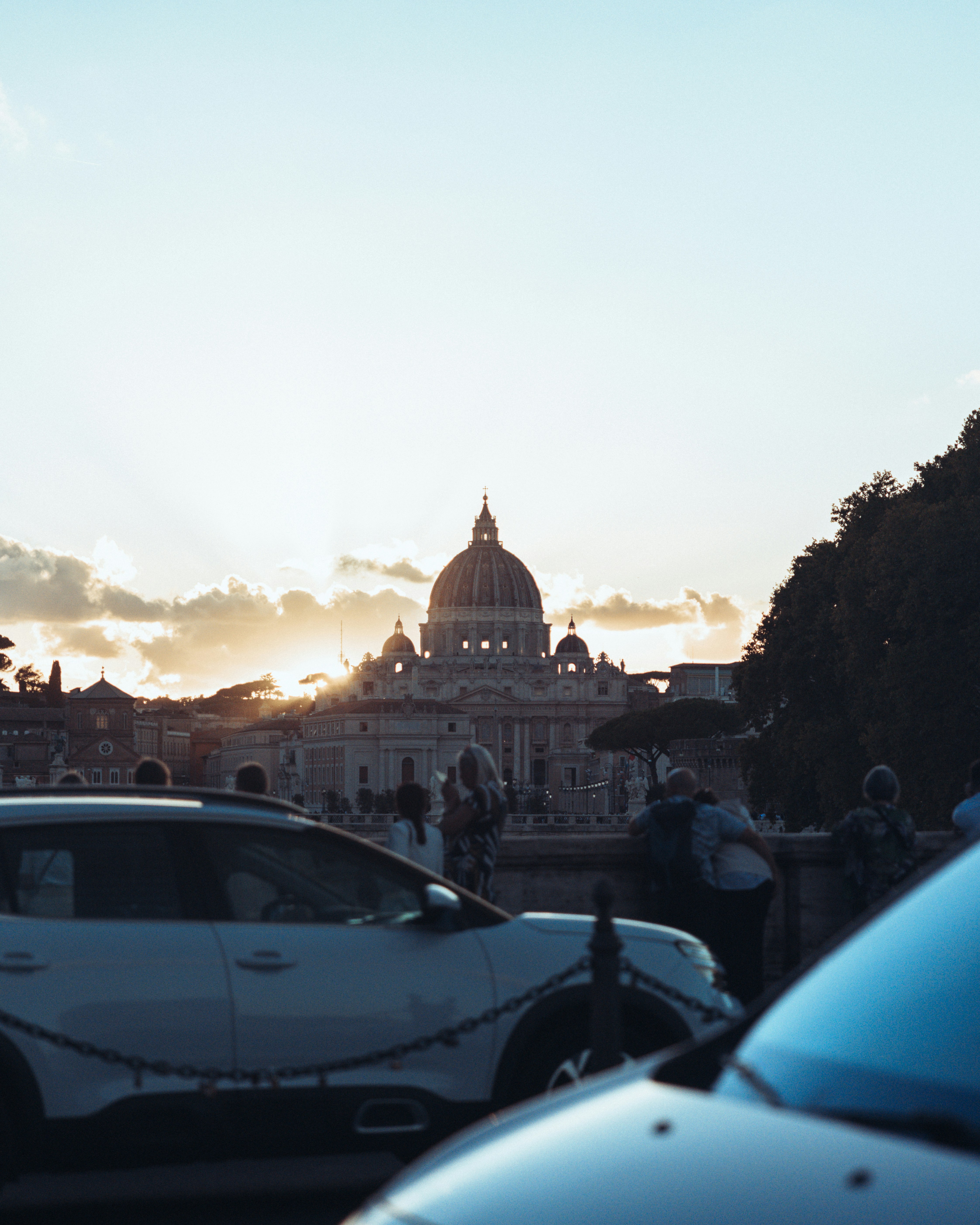 Dusk Over Rome: The Dome of St. Peter's Rising Above a Riverside Scene