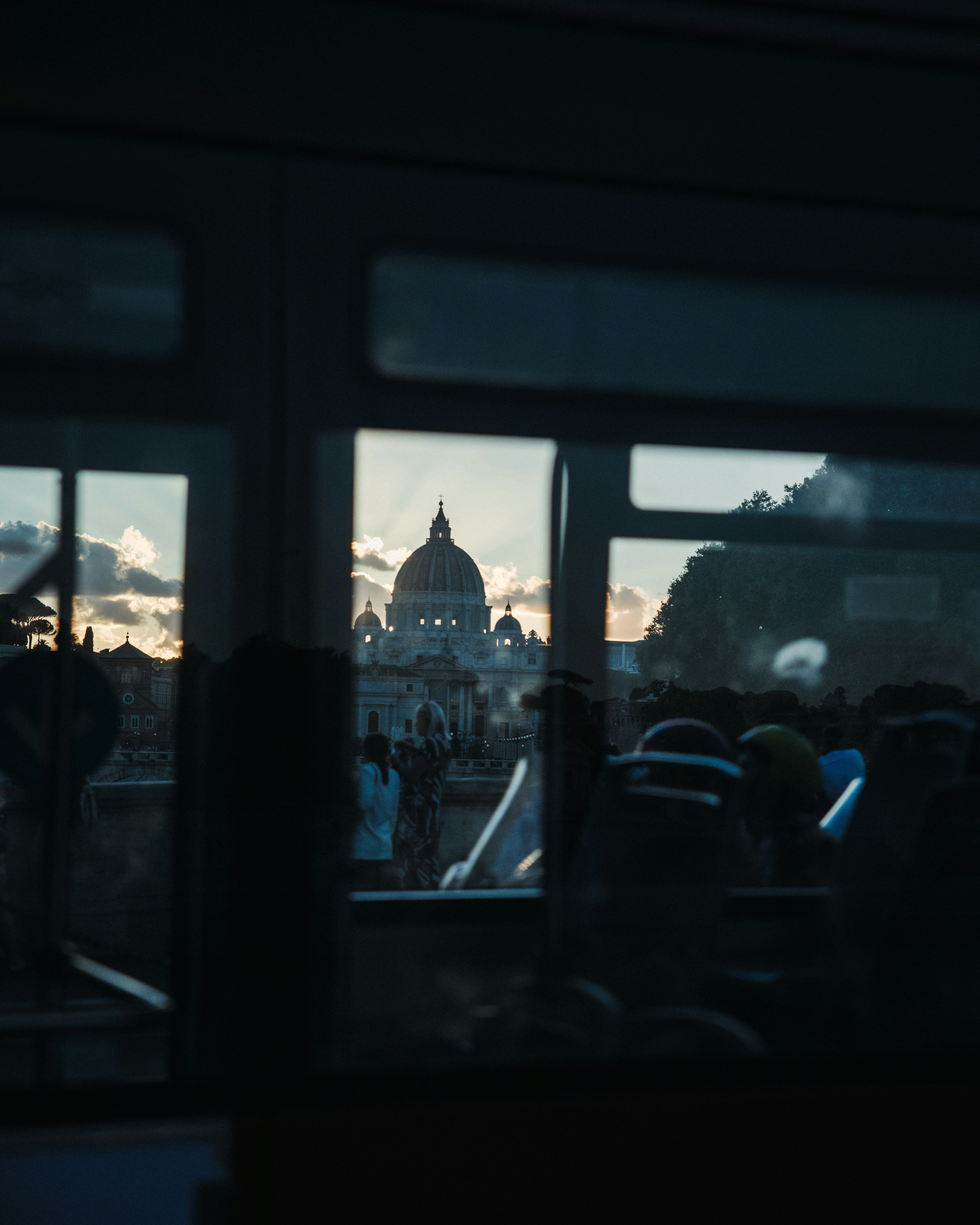 Dome Framed by Glass: Twilight Cityscape Through a Moving Bus Window