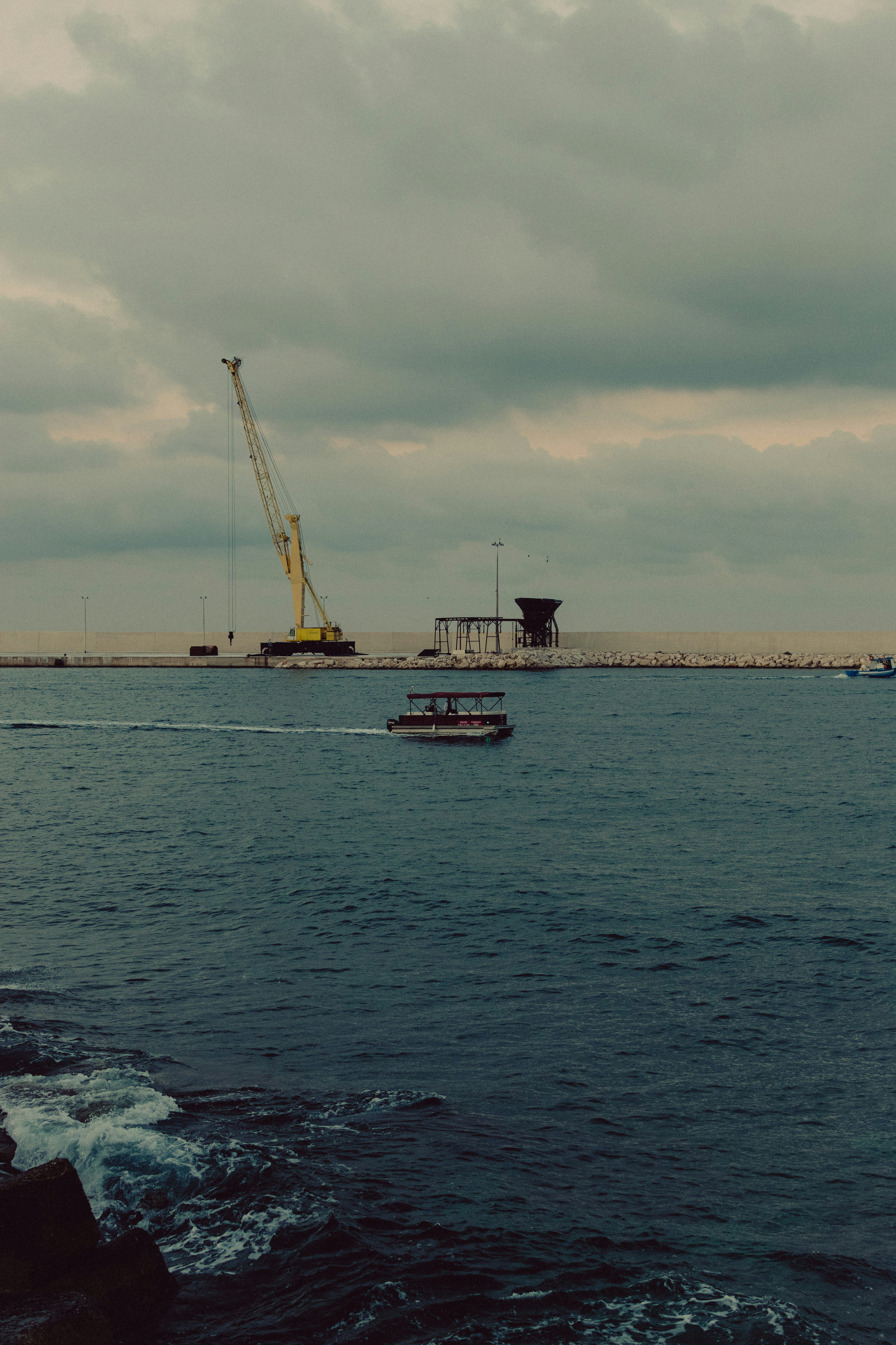 Yellow Crane at the Breakwater: A Quiet Harbor Moment
