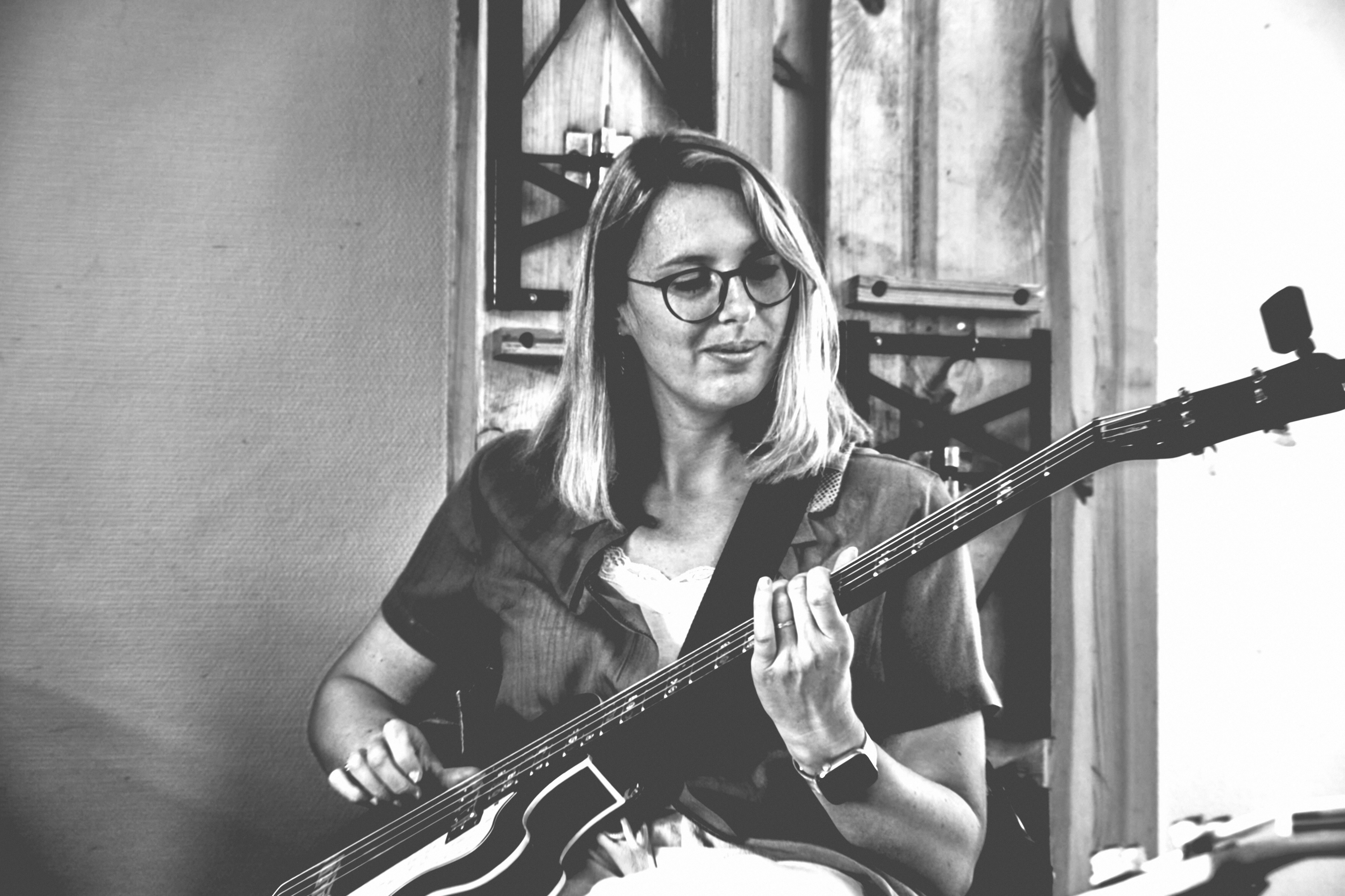 Monochrome Rehearsal: Fingers Glide Across the Bass in Quiet Focus