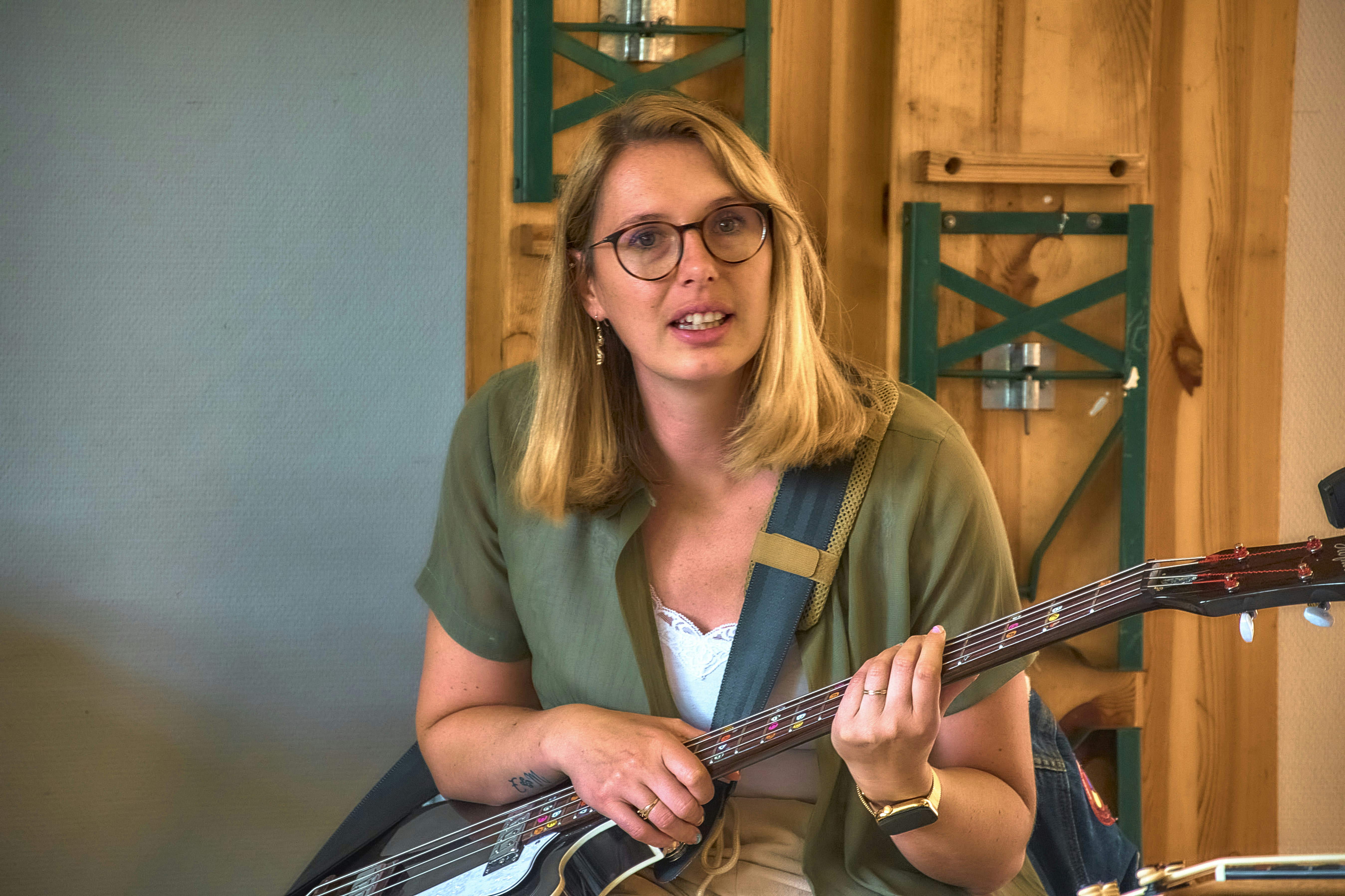 Warm-Glow Rehearsal: A Bassist in a Timber-Walled Studio