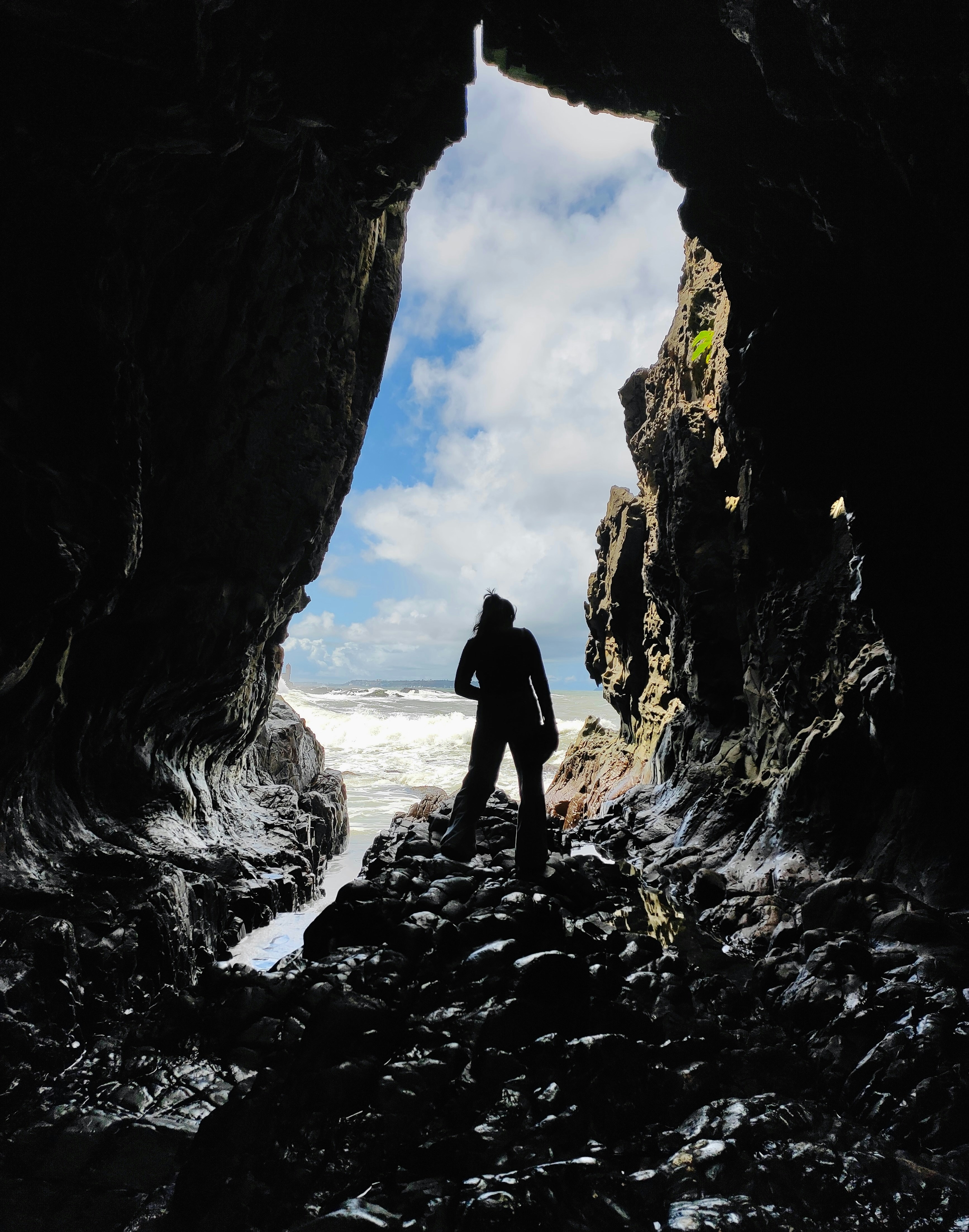 Lone Figure at the Sea Gate: Light Beyond the Cavern