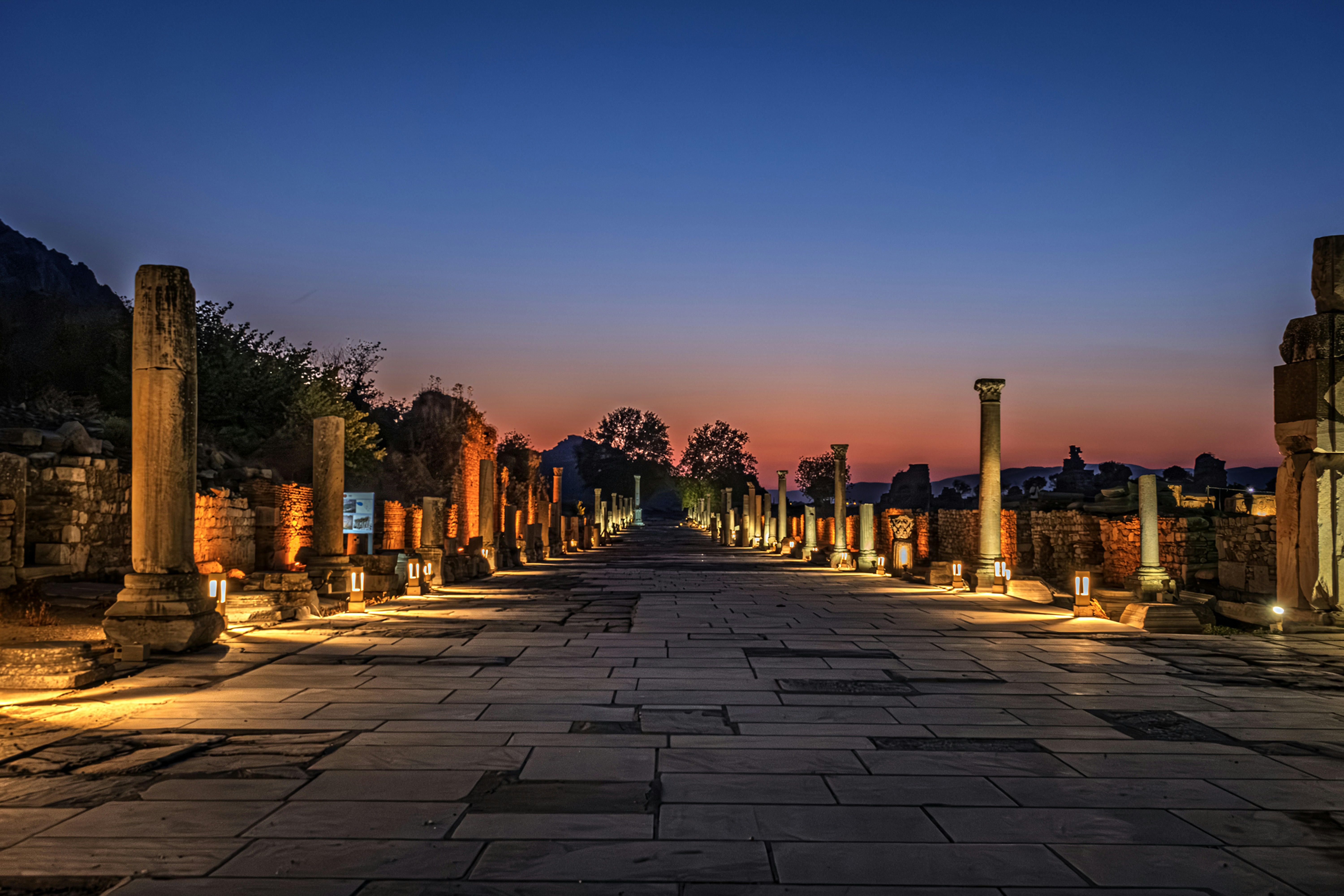 Twilight Colonnade: Amber-Lit Path Through Ancient Ruins Arcade