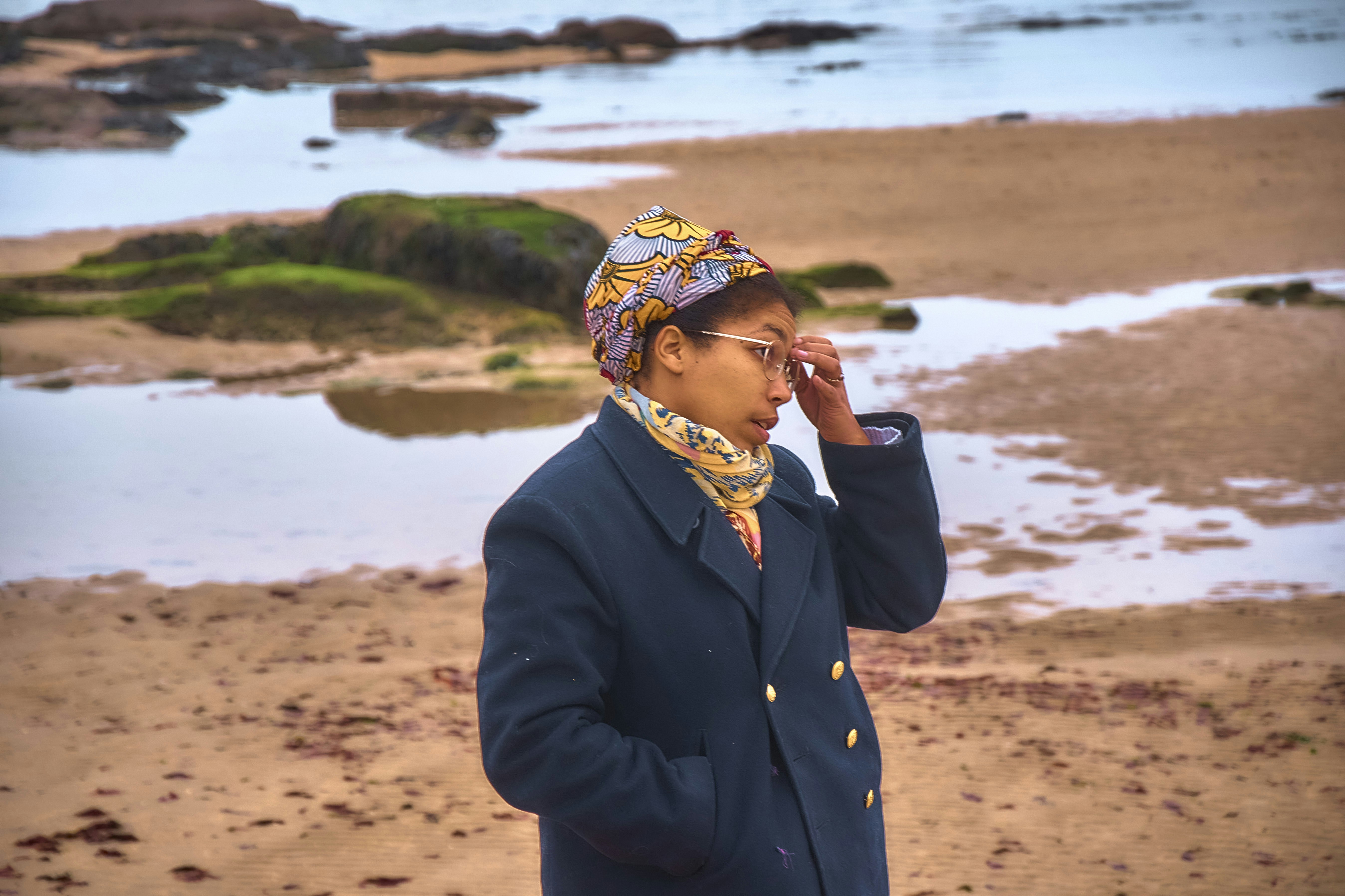 Woman in coat on a sandy beach