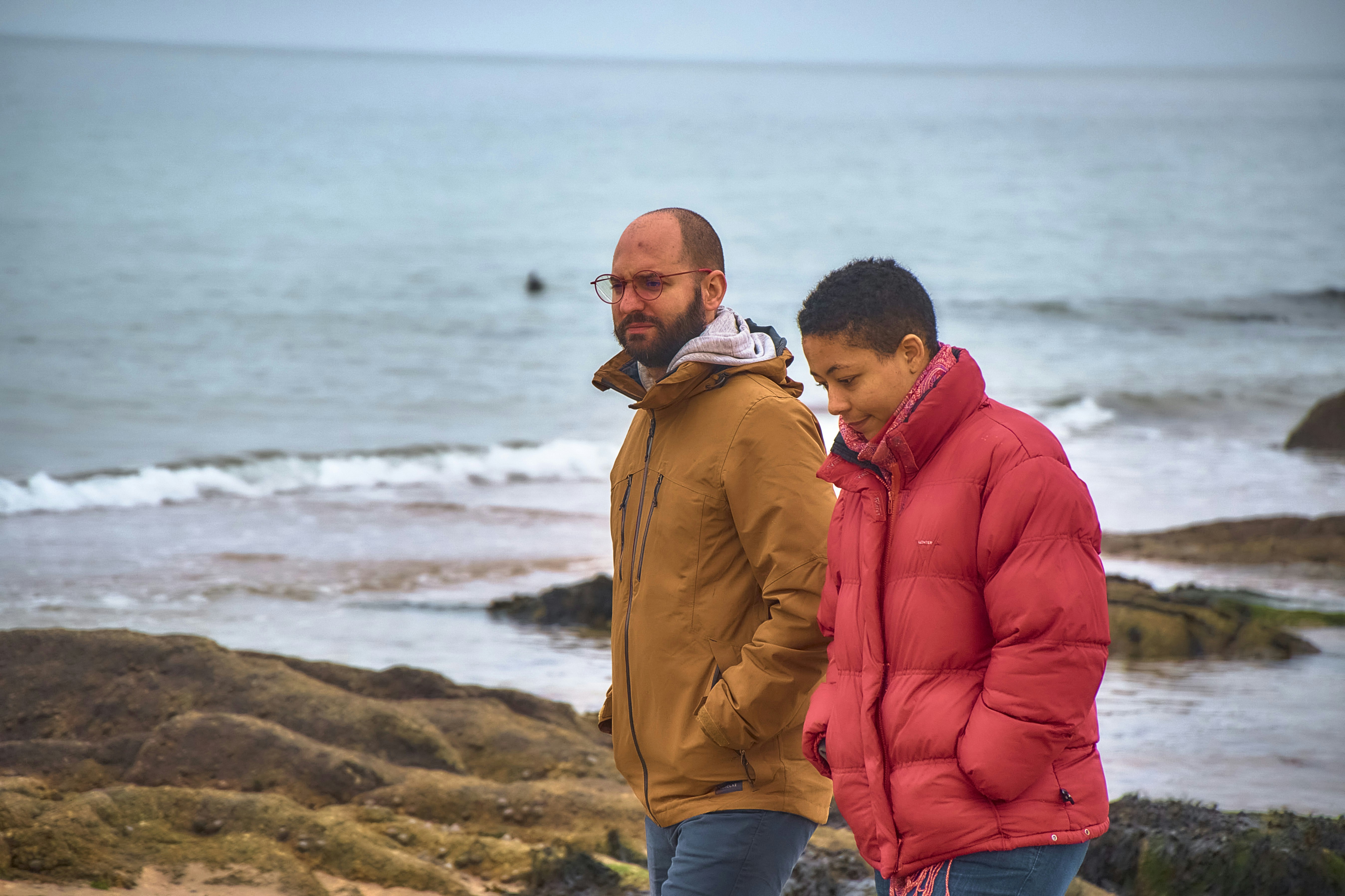 Weathered Rocks and Warm Jackets: A Quiet Seaside Walk