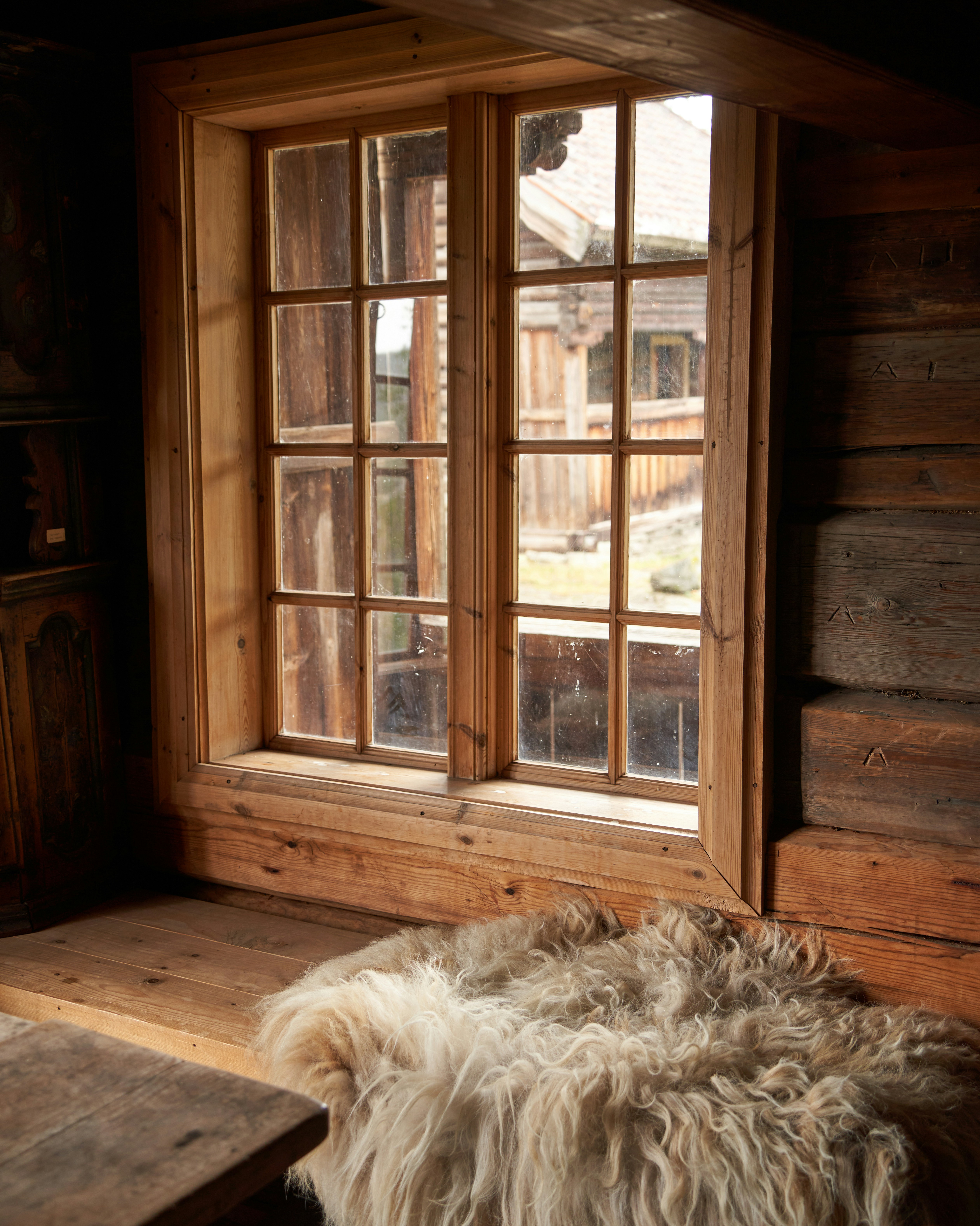 Windowed Warmth: Soft Light in a Rustic Log Cabin