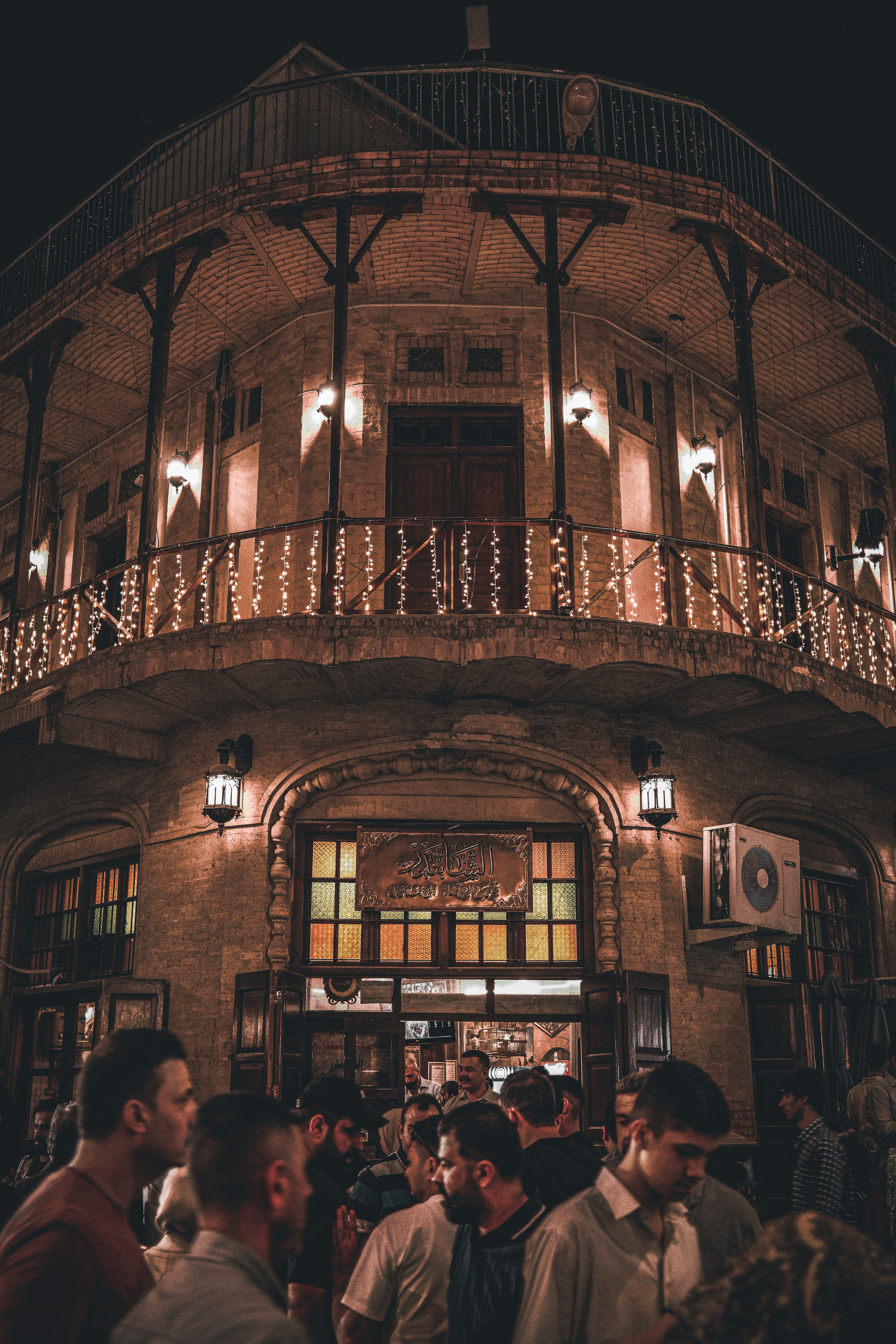 Balcony Glow Over a Crowded Brick Facade at Night