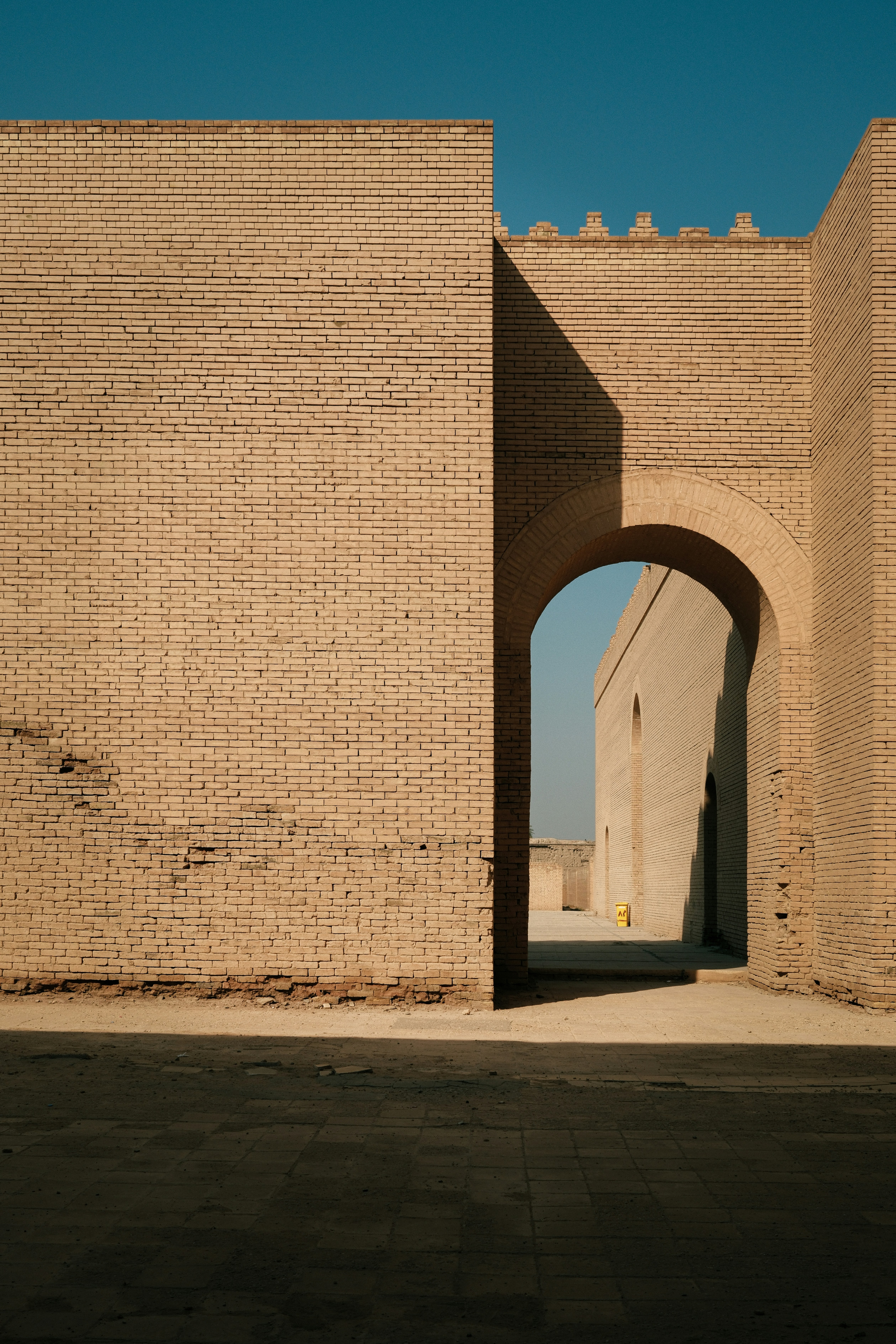 Archway of Light: A Quiet Passage Between Brick Walls