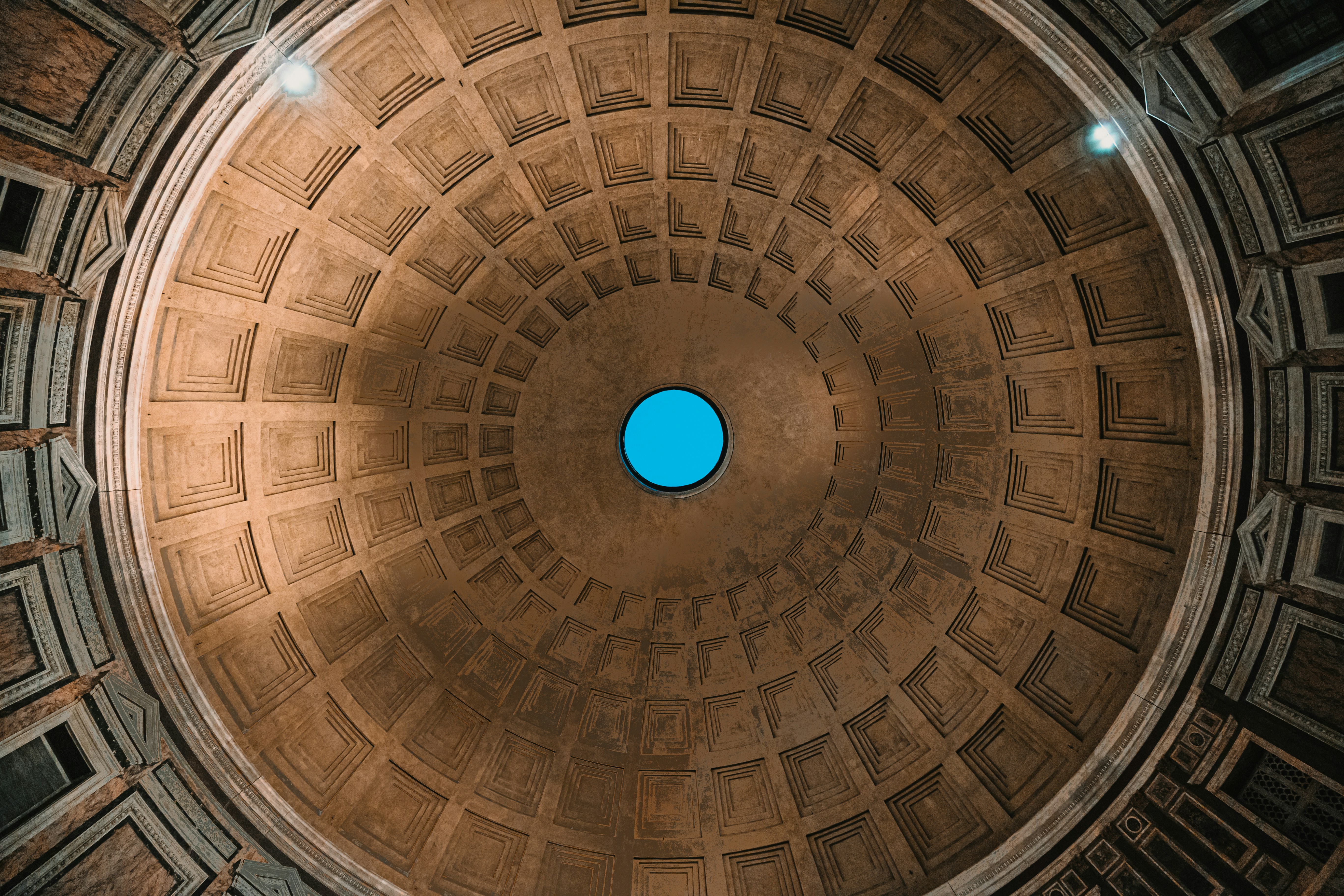 Direct overhead view of the Pantheon's coffered dome ceiling, focused on the central circular opening, the oculus.