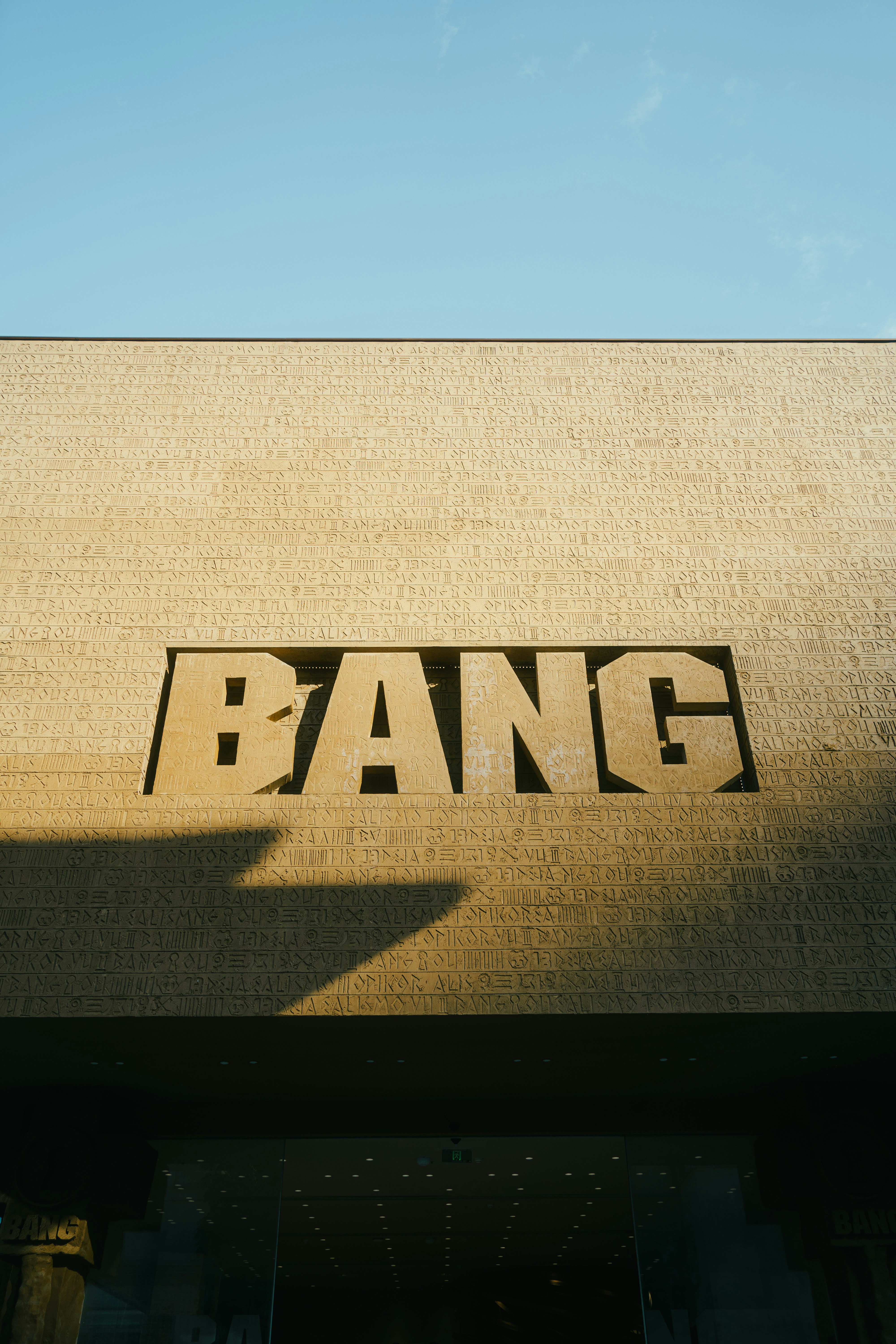 Bold BANG: Shadowed Entrance Under a Clear Sky