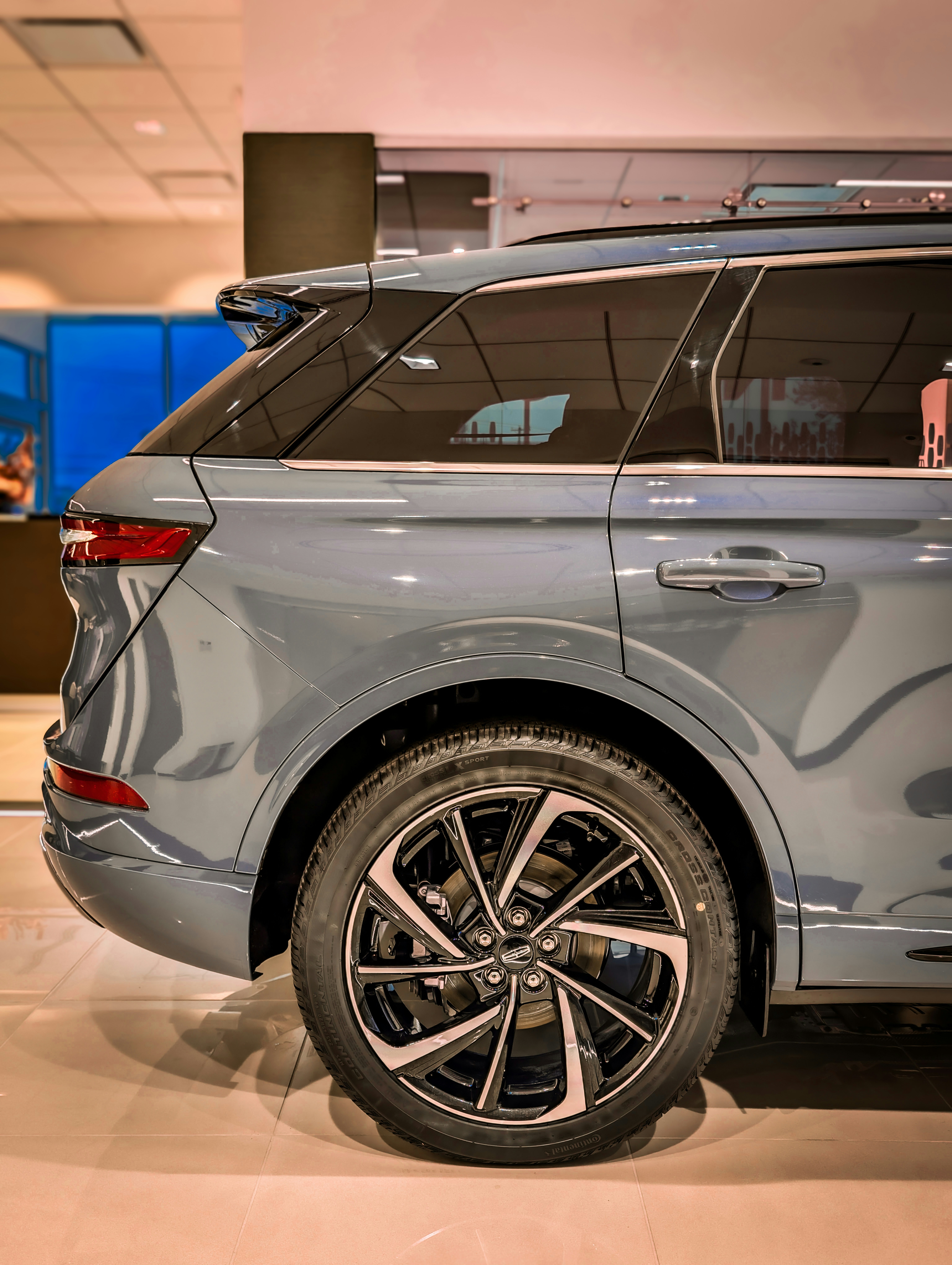 Side Profile of a Modern SUV: Wheel and Rear Window Highlighted