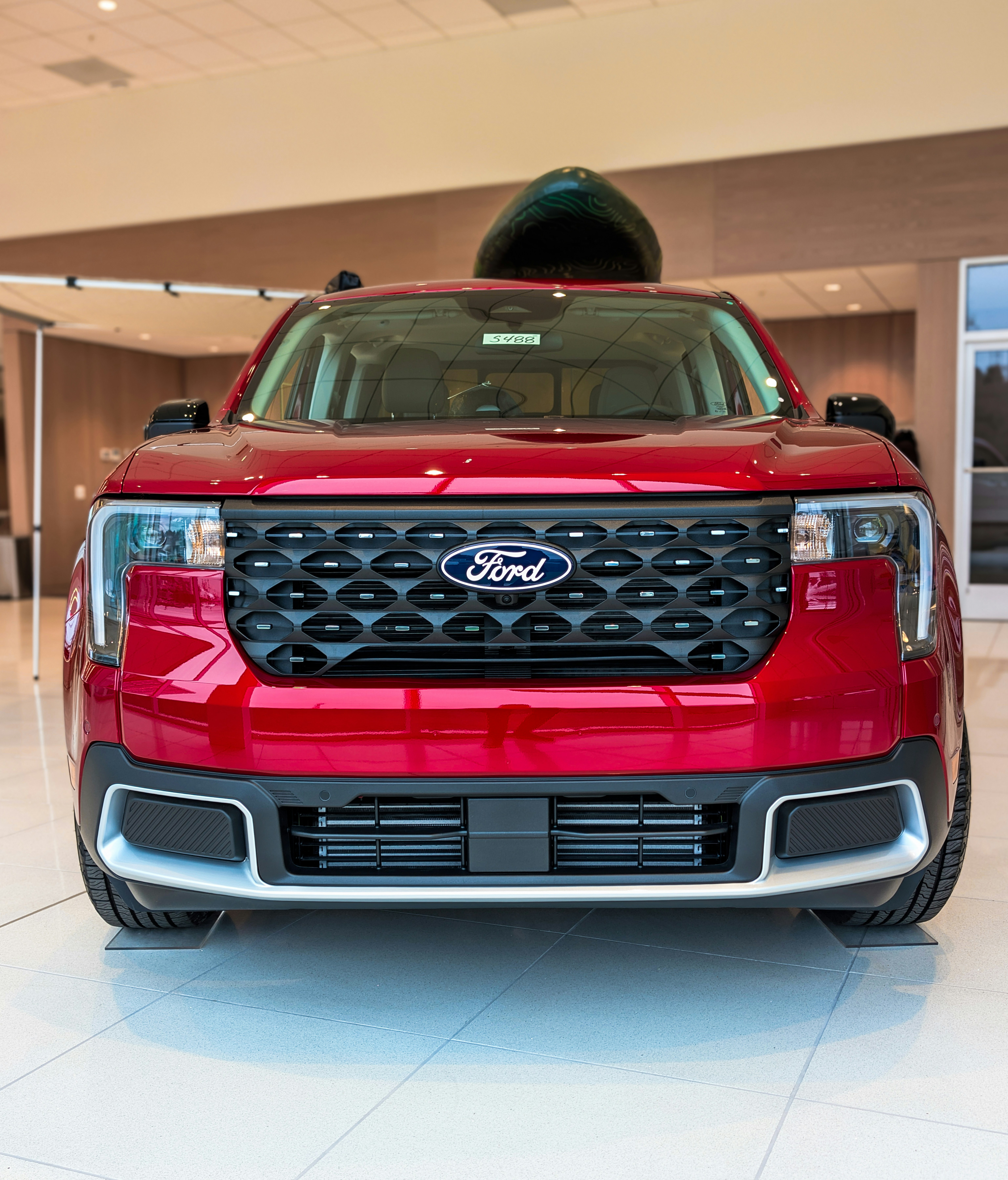 Rapid Red Ford Explorer embodies the spirit of adventure. With a kayak mounted high, its sleek grille and modern design promise thrilling road trips and unforgettable outdoor escapes.