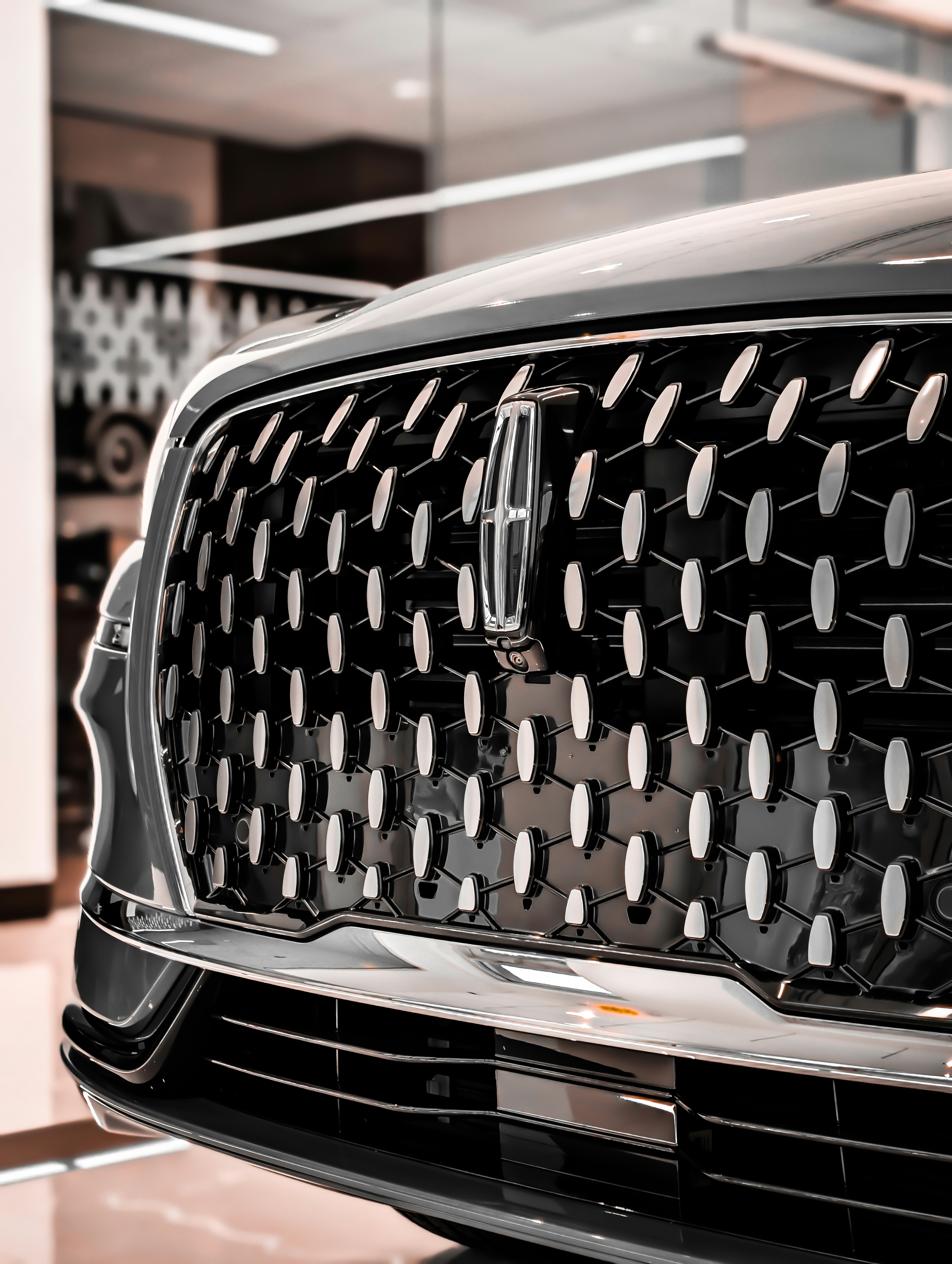 This stunning capture highlights the mesmerizing geometric intricacies of the Lincoln grille. The chrome details shine with unparalleled elegance, embodying pure luxury and sophisticated automotive craftsmanship that demands immediate attention.