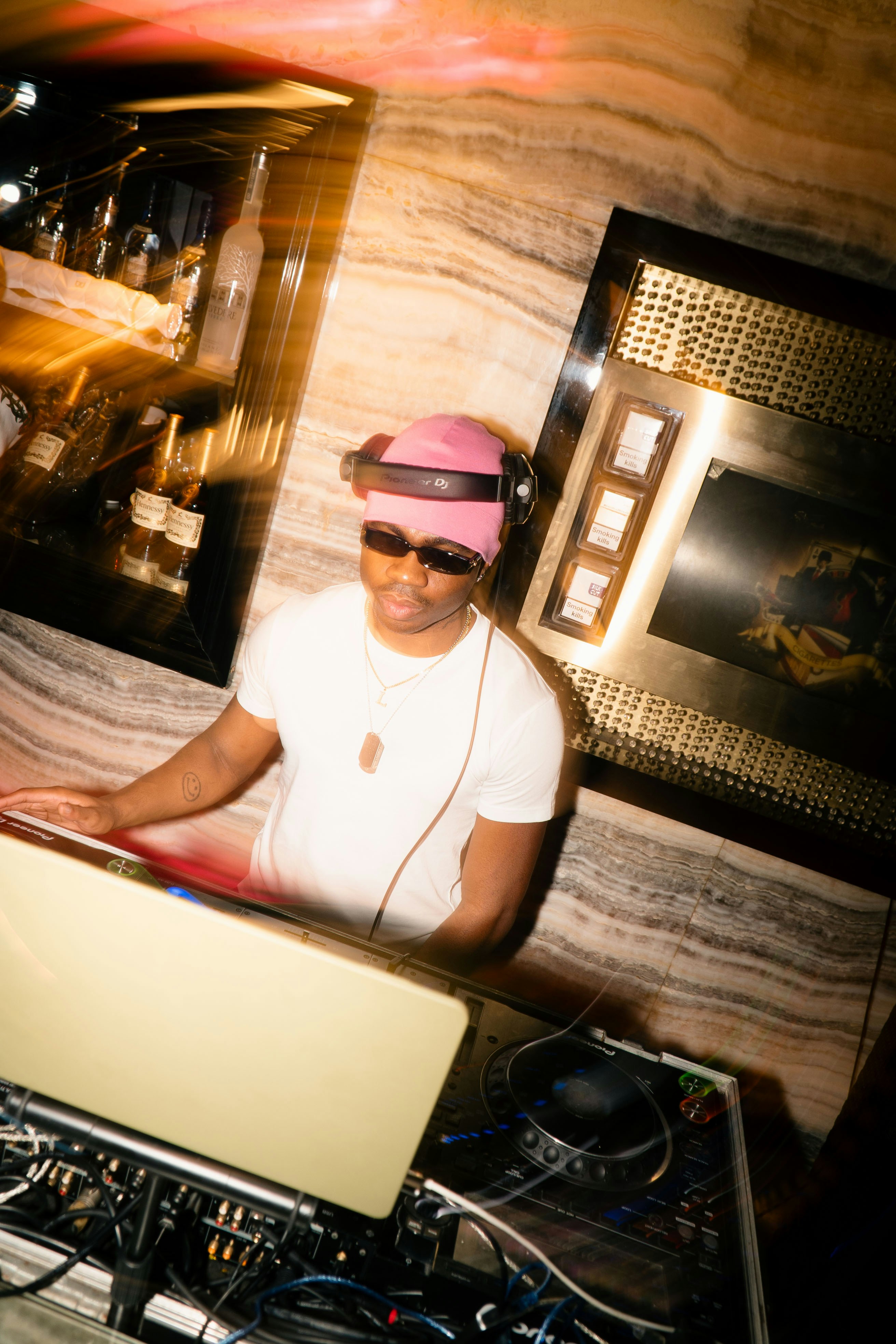 Dj wearing pink beanie and sunglasses playing music. photo – Free Music ...