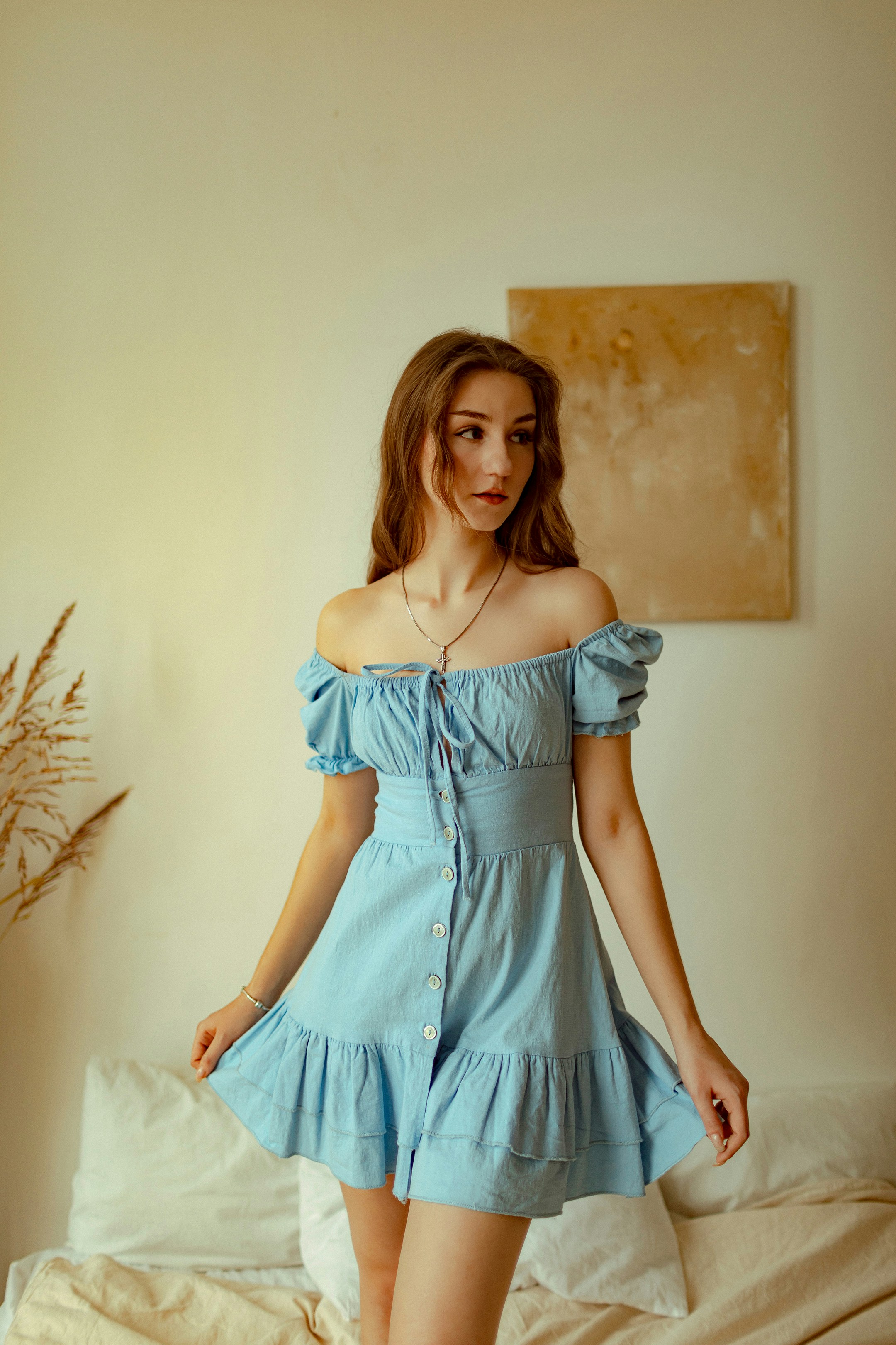 Pastel Poise in a Sunlit Room: Portrait of a Woman in a Blue Off-Shoulder Dress