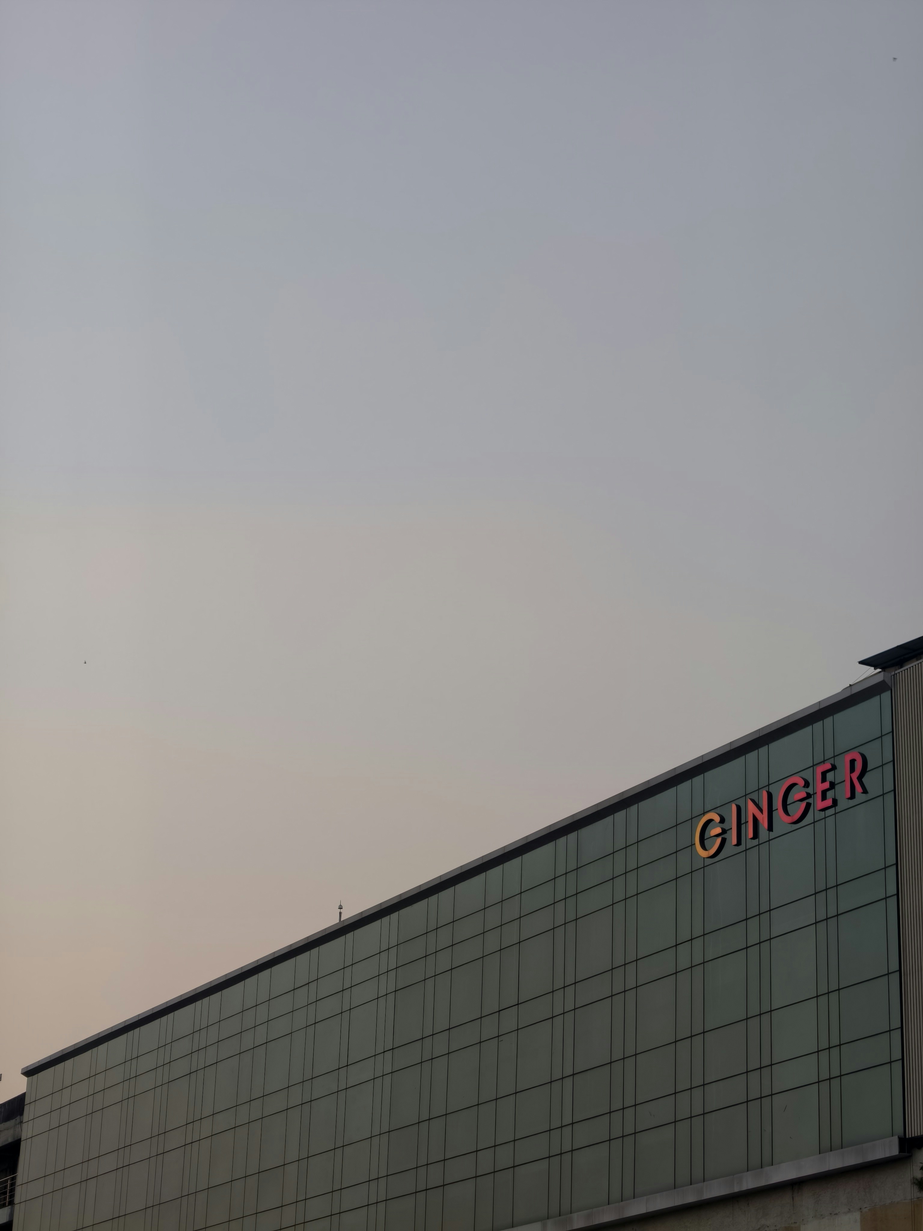 Building with a "ginger" sign at dusk