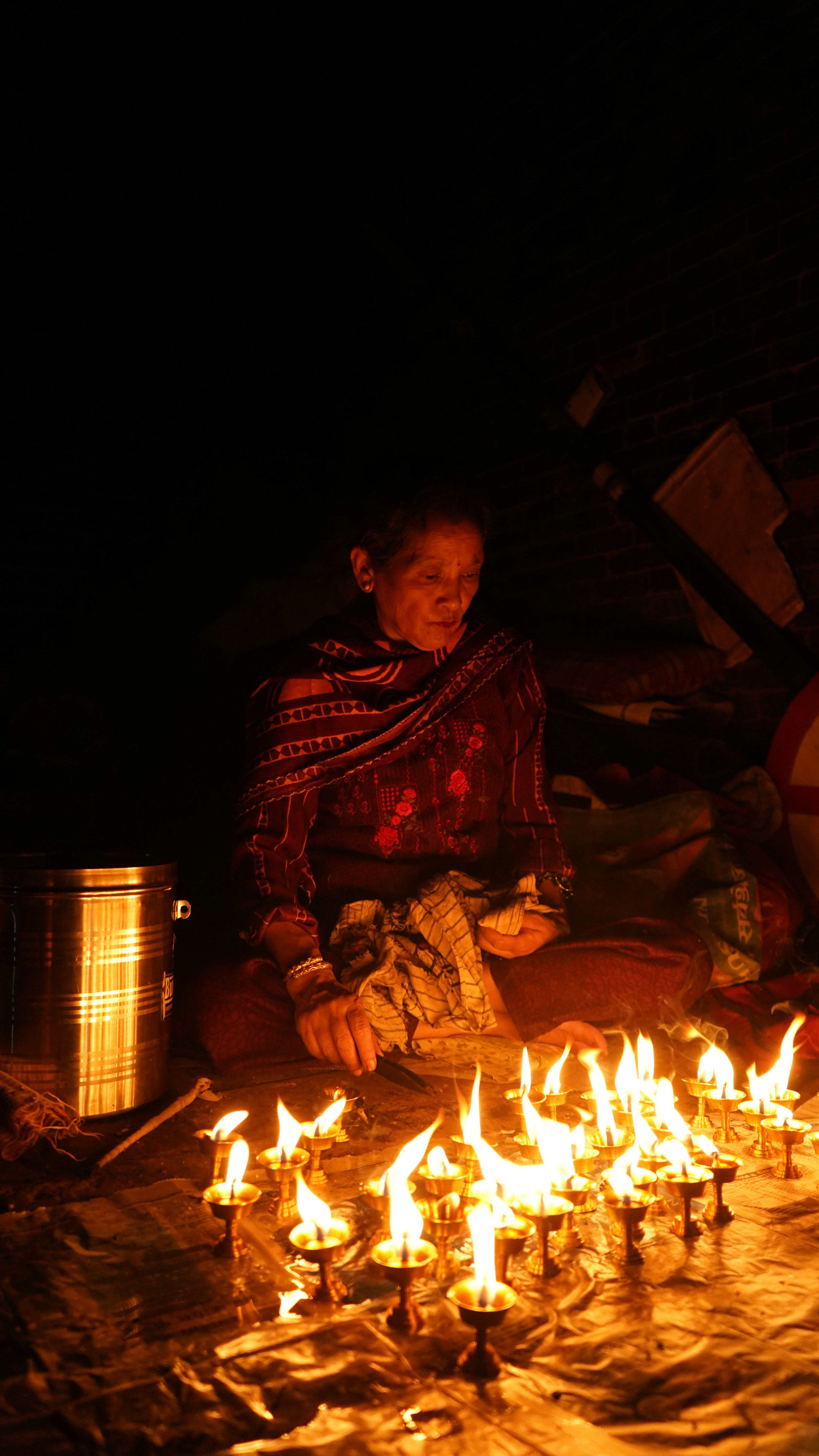 Ember Vigil: A Woman in a Red Shawl Tending the Flame
