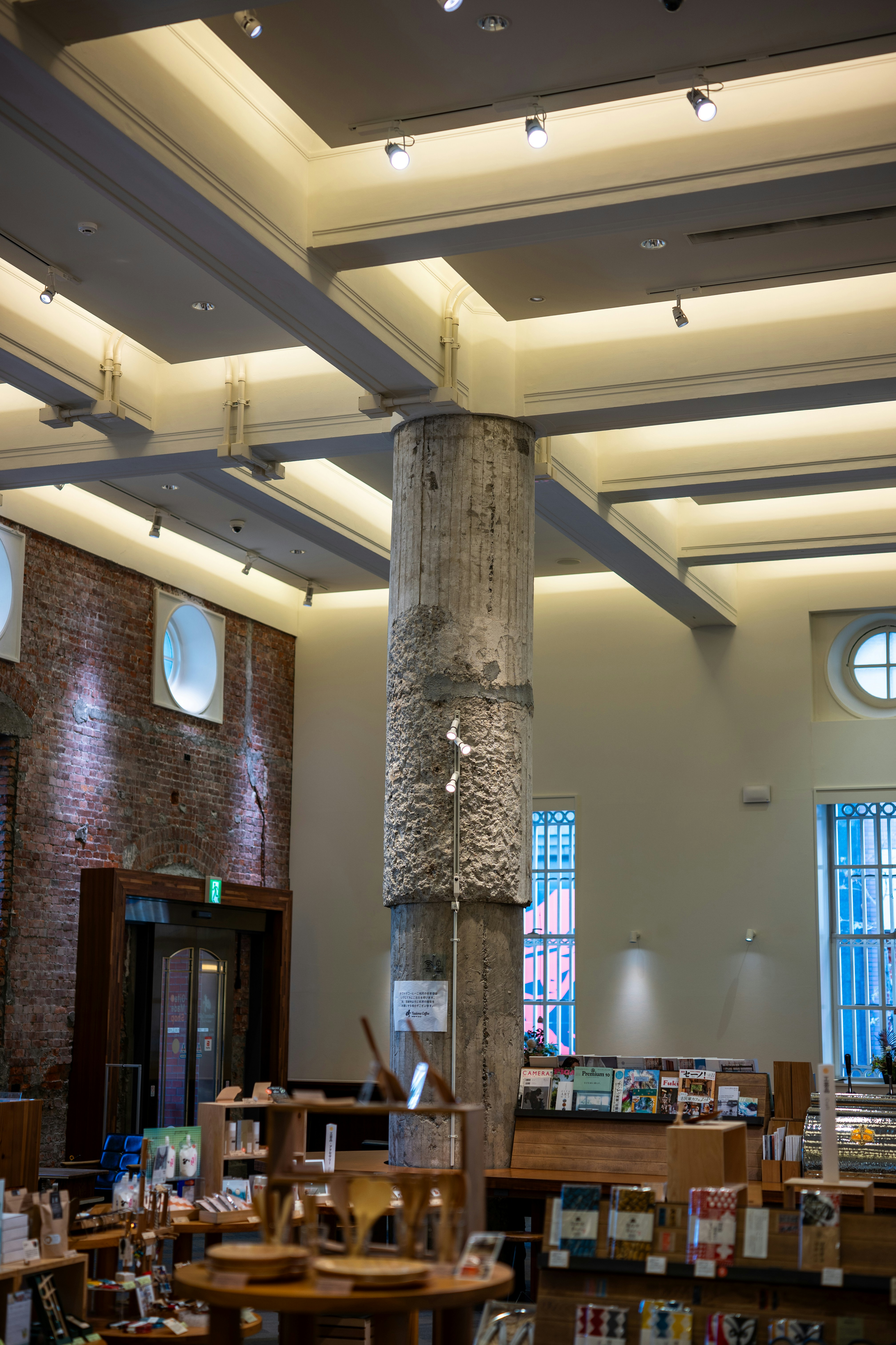 Center Pillar in a Brick Library Bathed in Warm Overhead Glow