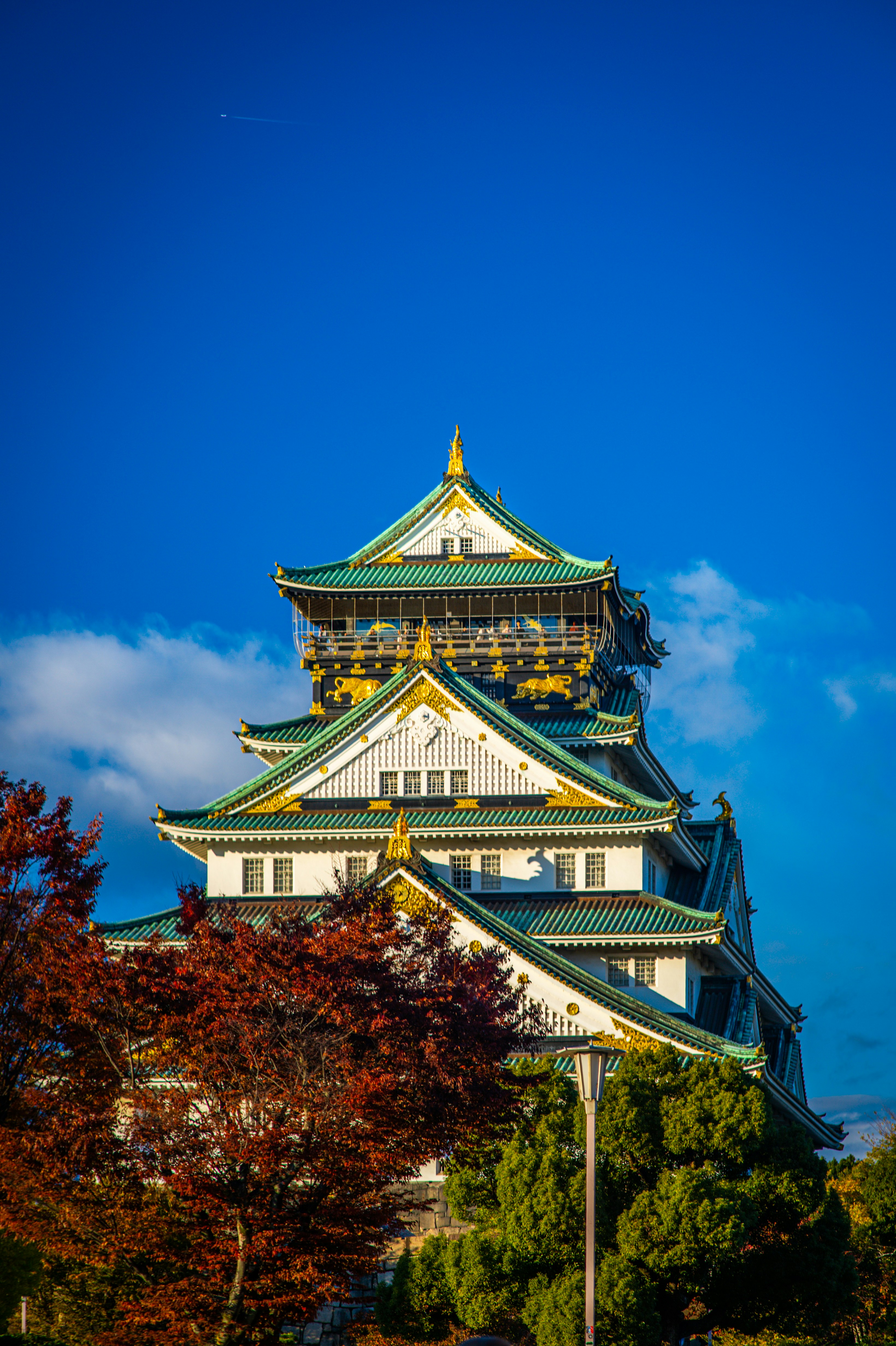 Emerald-Tiled Castle Rising Under a Cerulean Sky