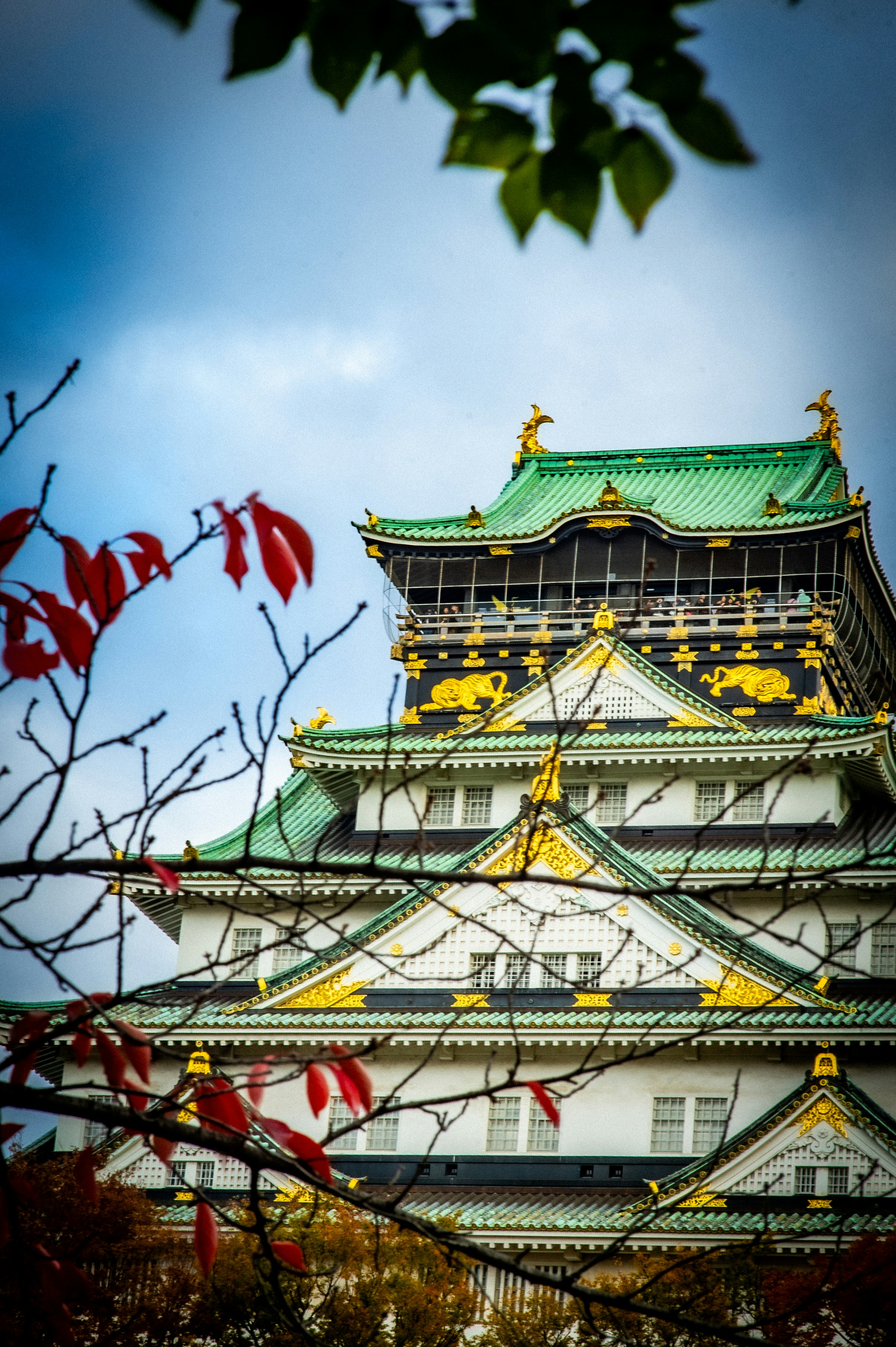 Emerald-Tiled Castle Rising Above Autumn Crimson Fronds