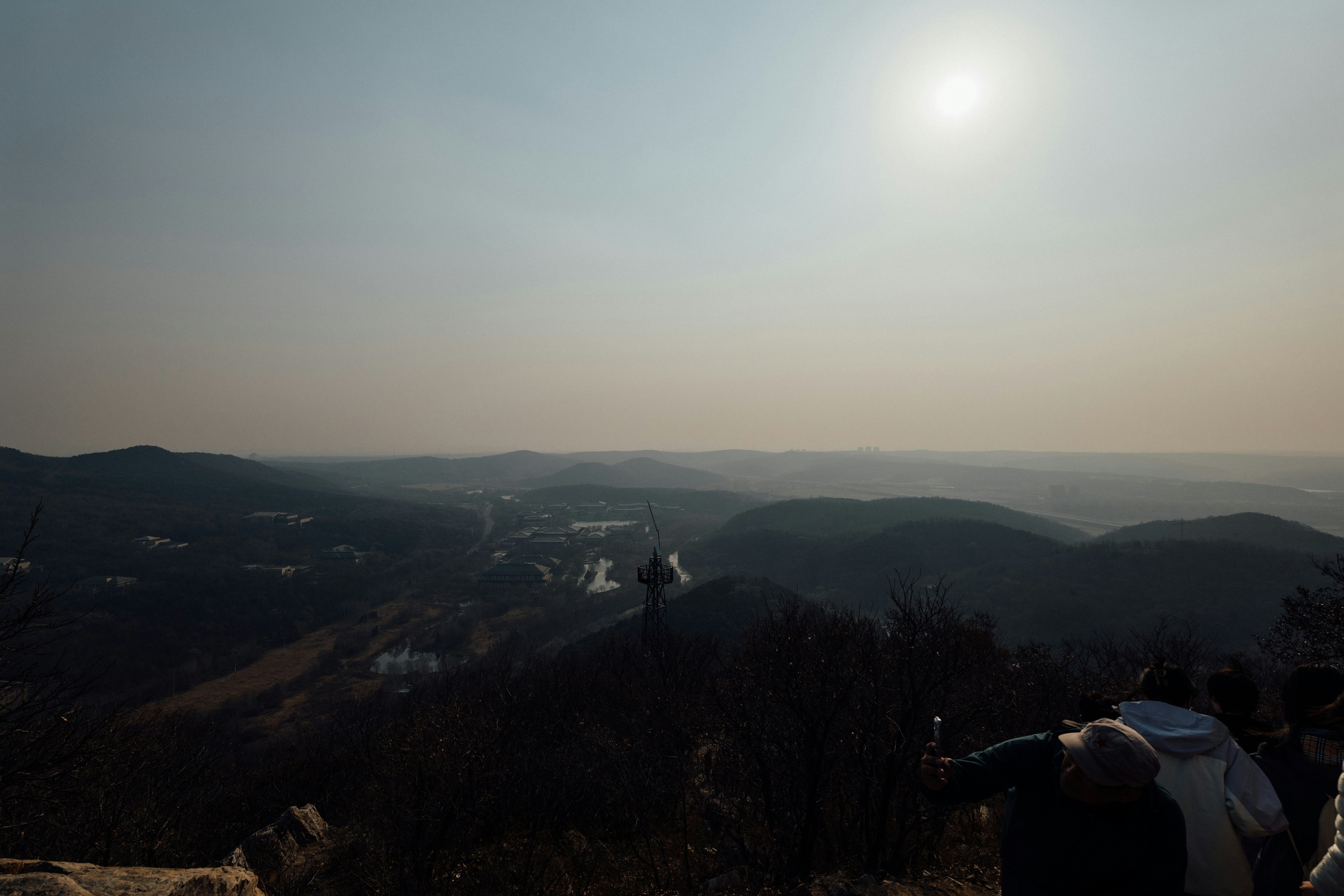Sun on the Skyline: A hazy ridge overlook over a quiet valley
