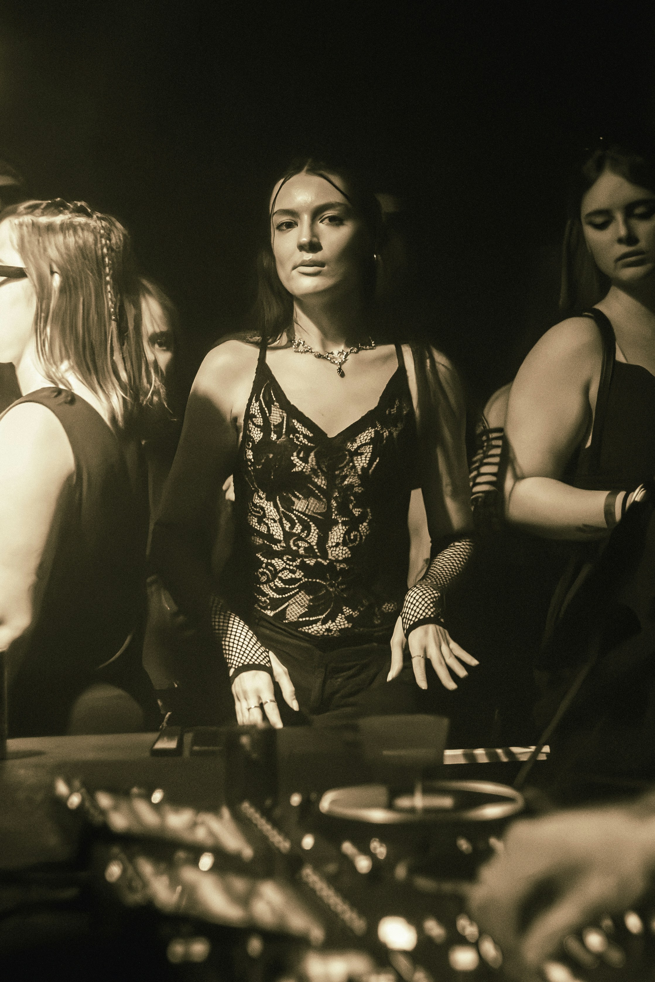 Lace in Low Light: Quiet Command at the Club Booth