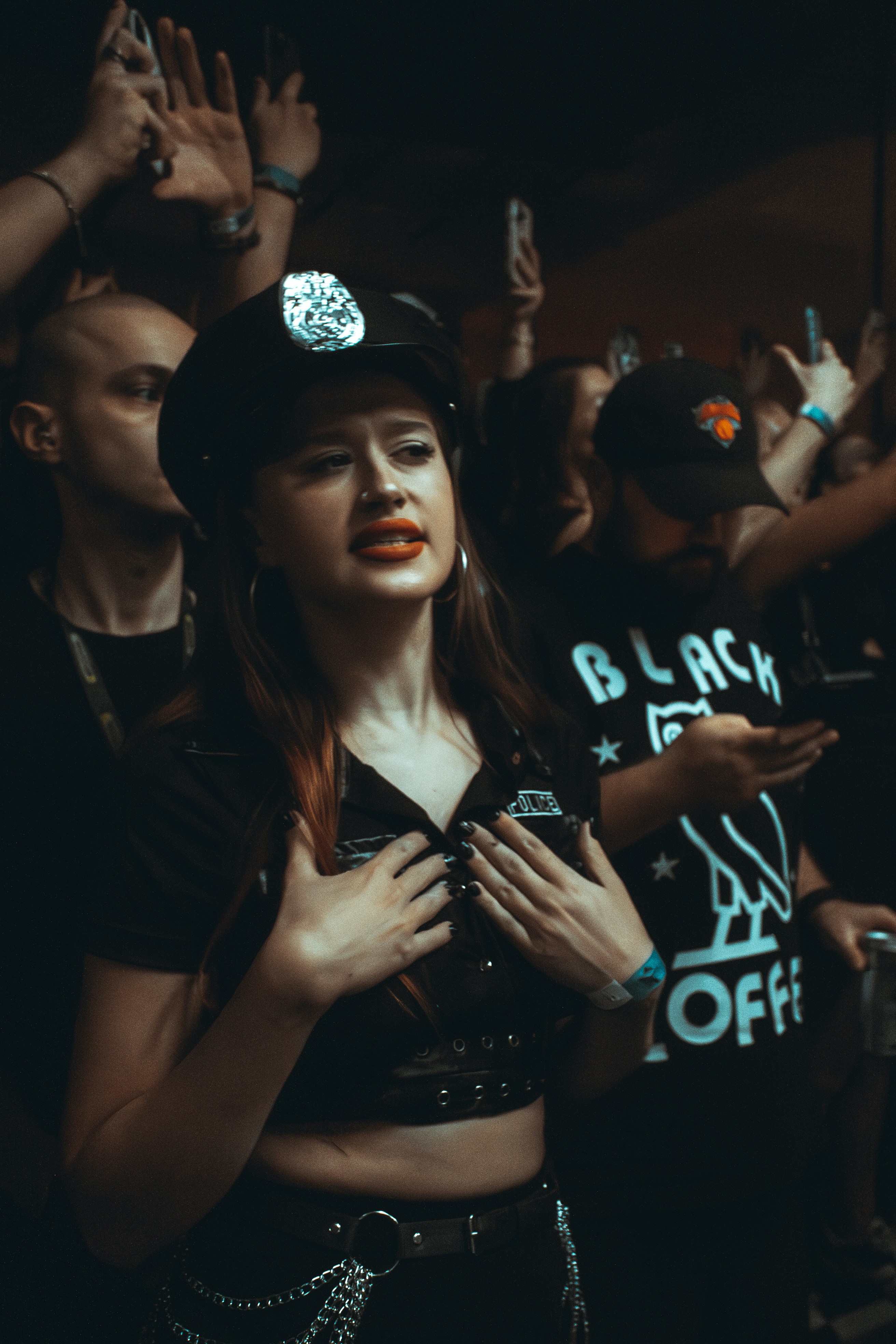 Neon Gaze at the Front: A Quiet Moment in a Packed Crowd