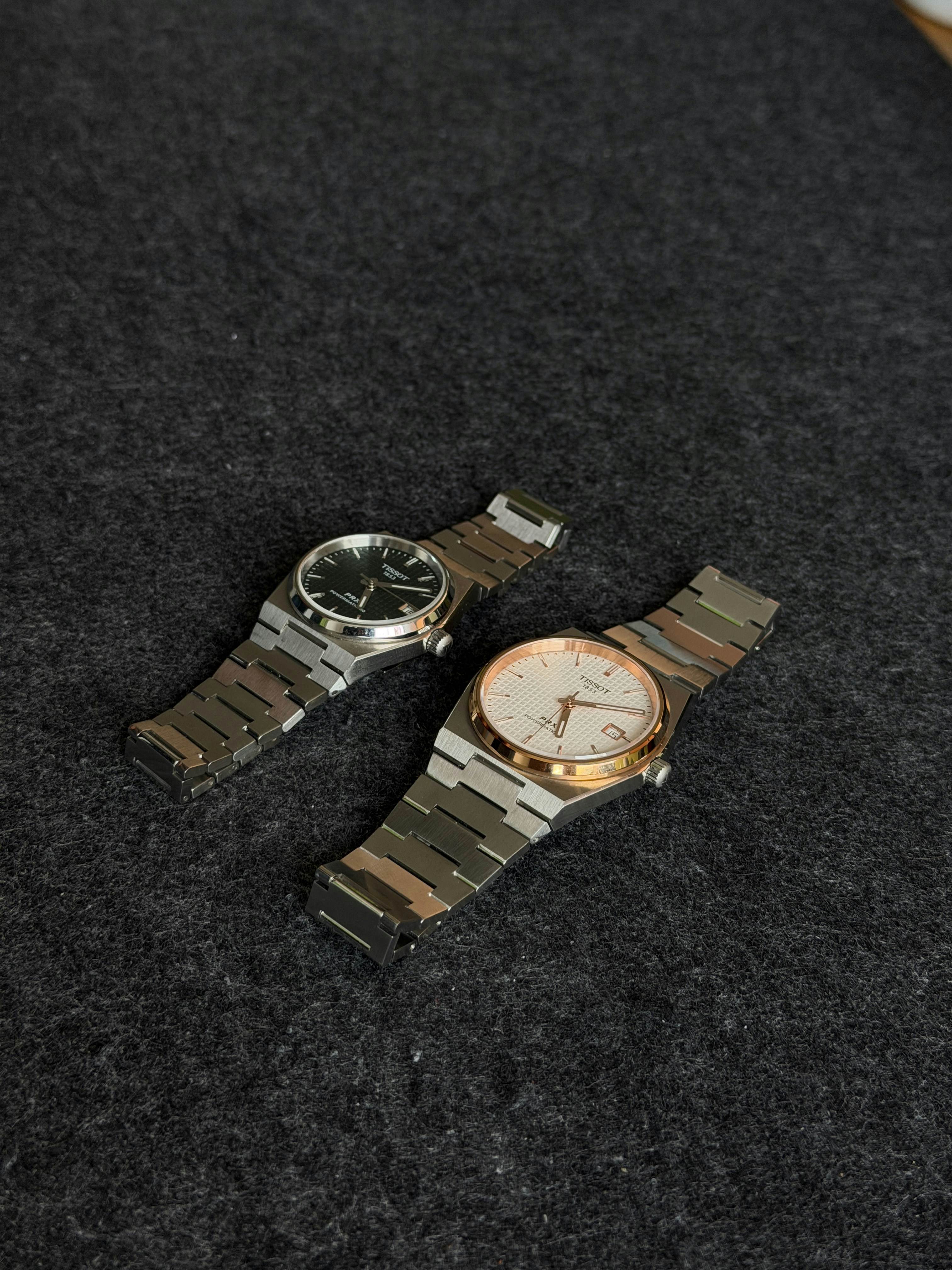 Charcoal Felt Twin Timepieces: Silver and Onyx Dials Side by Side