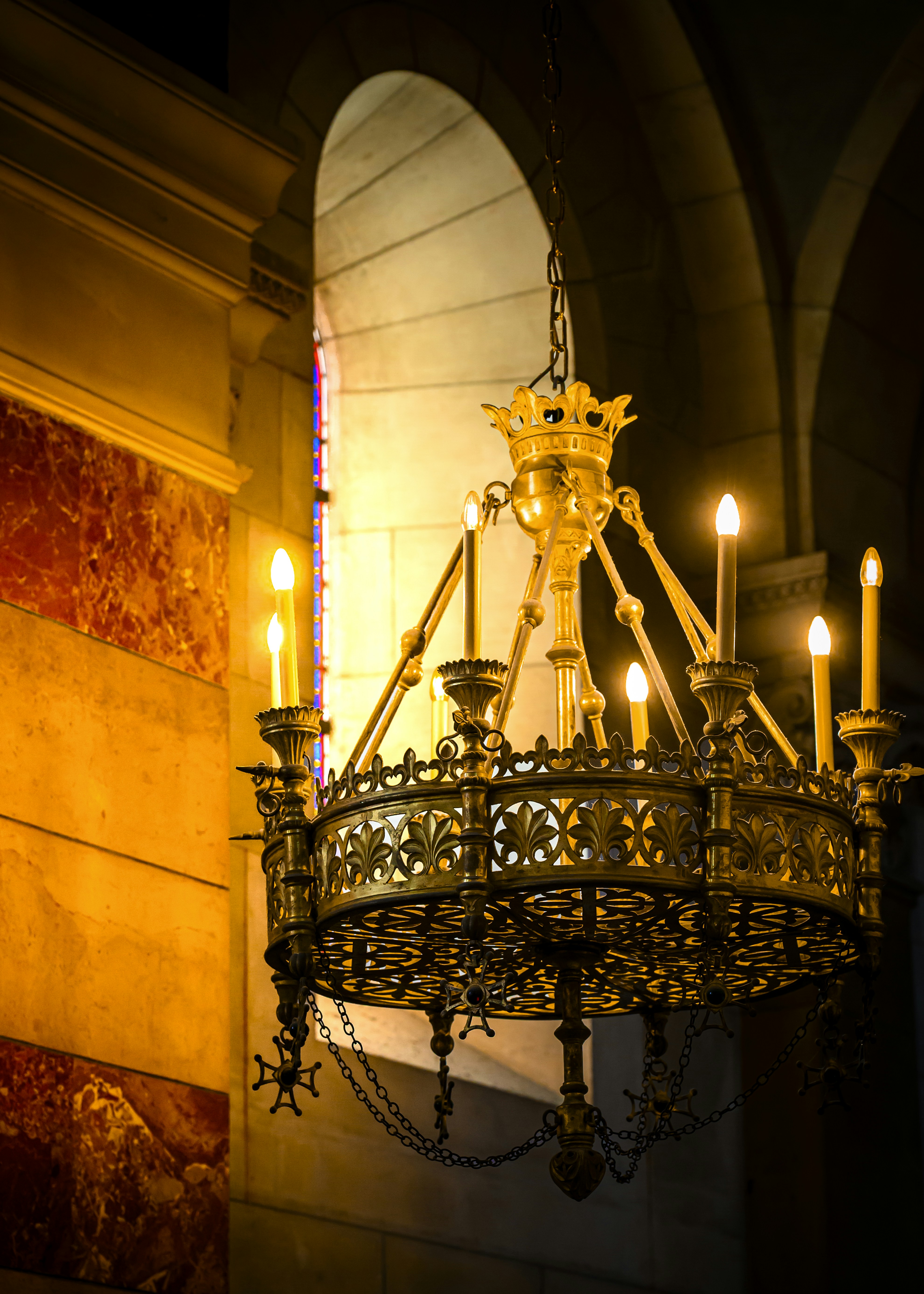 Candlelit Crown in a Cathedral: Amber Fire Graces Ornate Ironwork