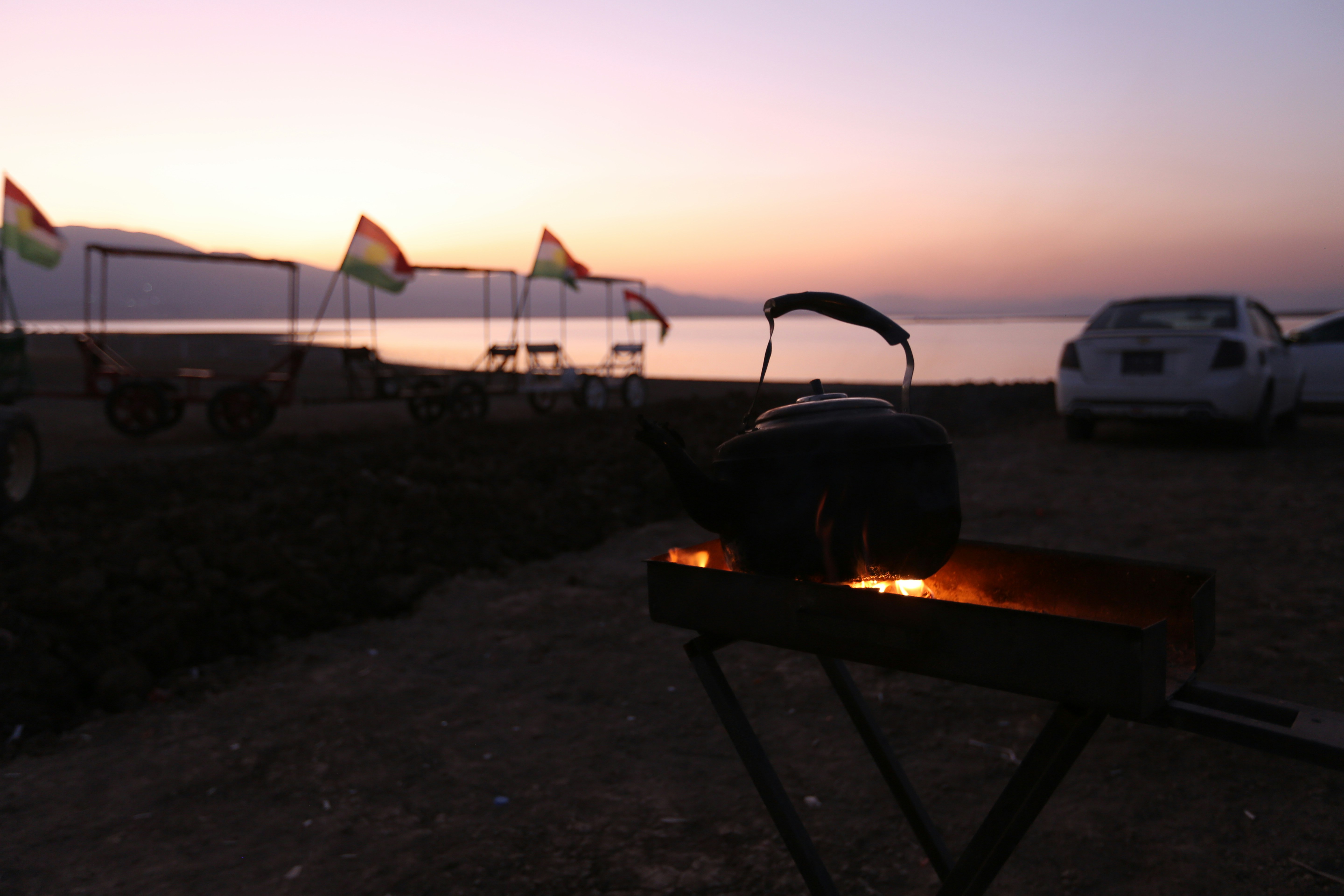 Ember at Dusk: A Kettle Basks on a Beachside Camp Stove