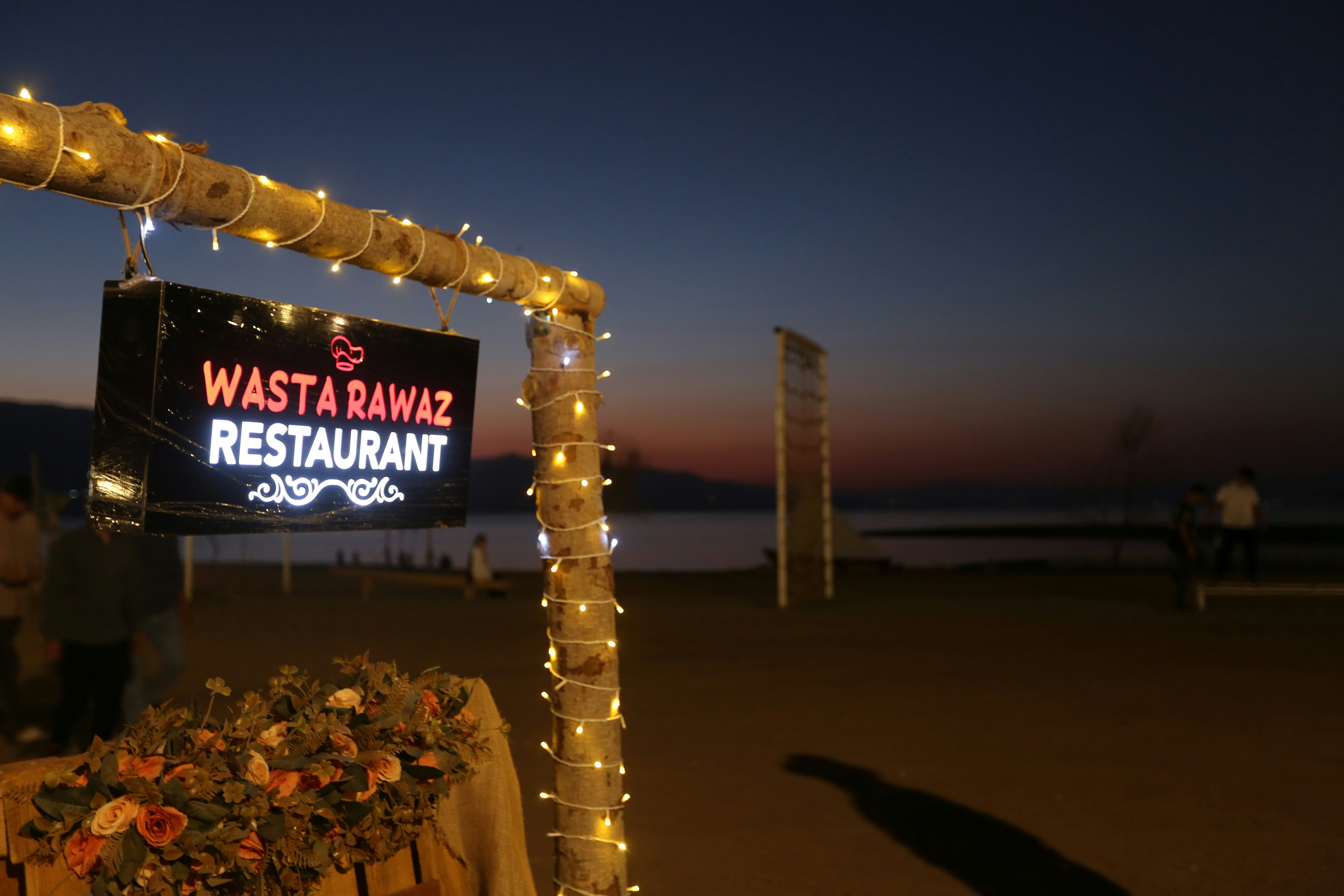 Wasta Rawaz Restaurant Sign Bathed in Dusk Glow