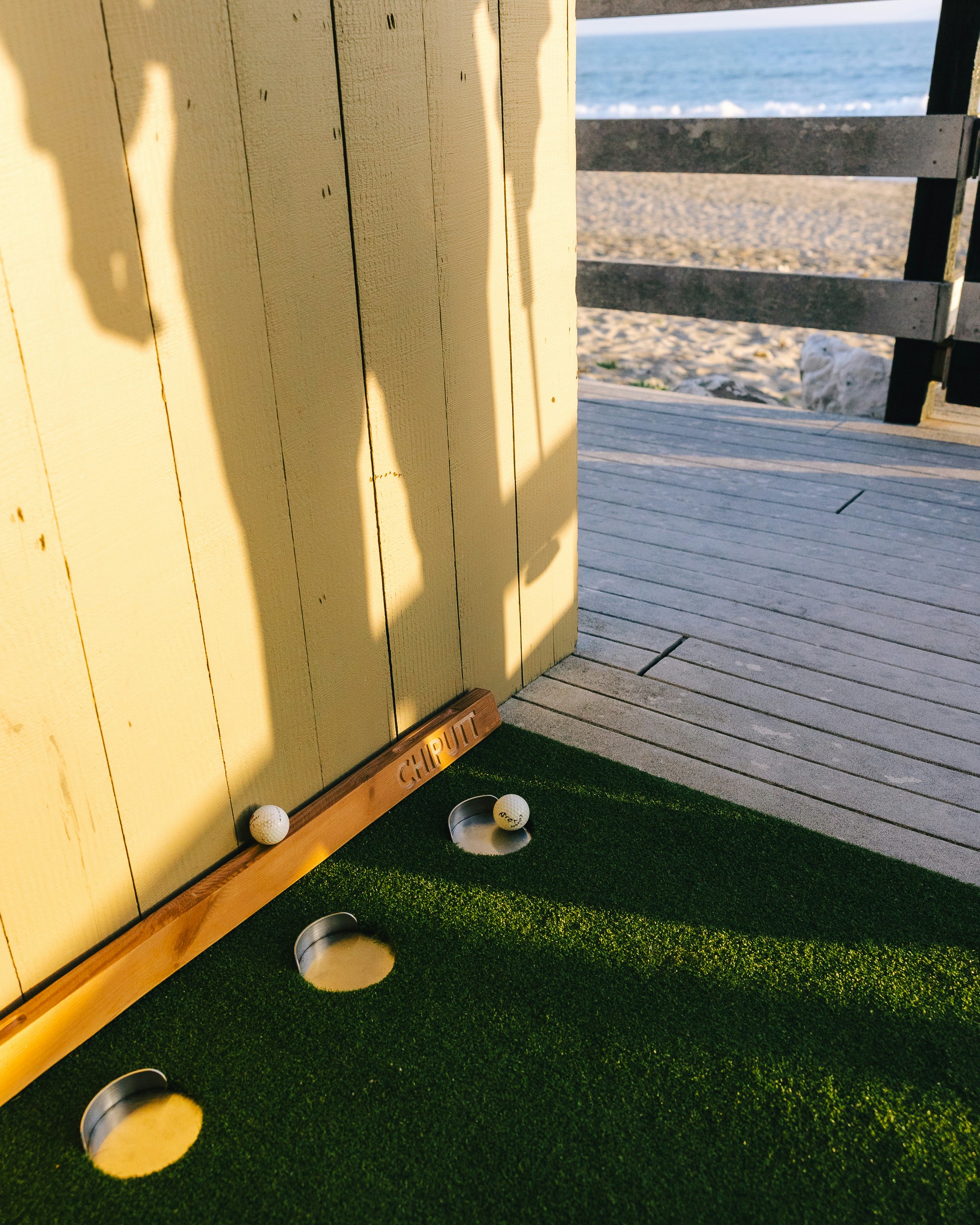 Sunlit Shadows Over a Beachfront Mini-Golf Tee
