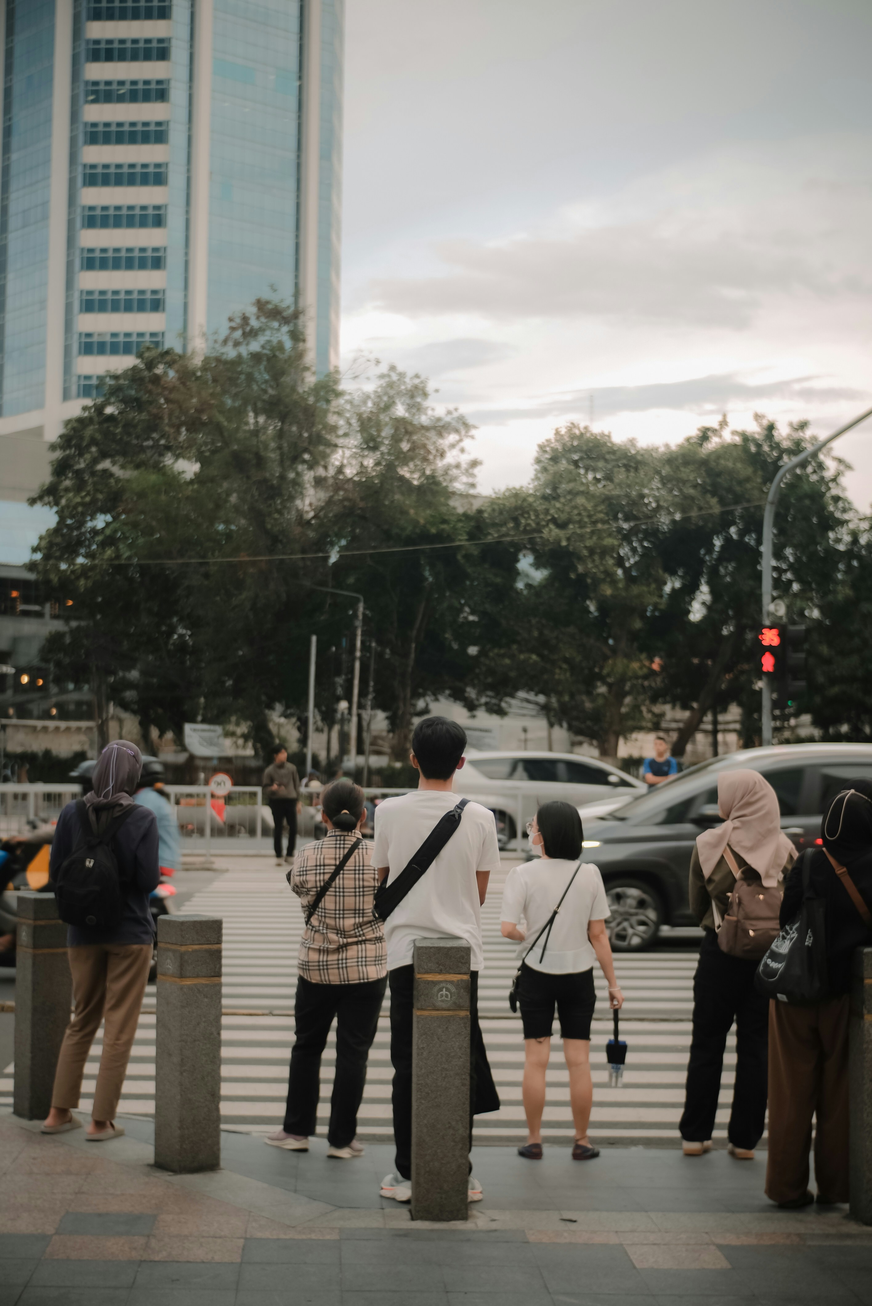 Crosswalk Cadence: City Pedestrians Pausing at the Edge of Traffic