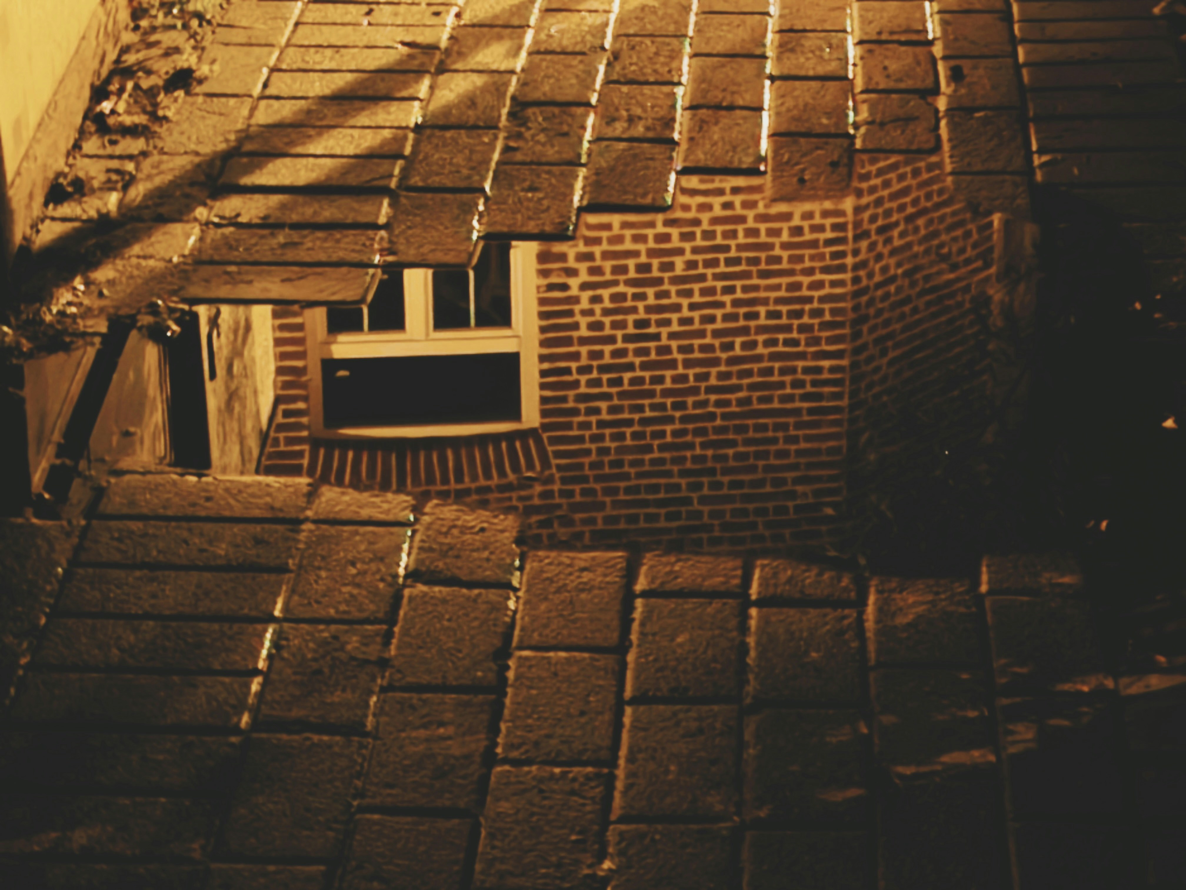 Amberlit Rooftop Window: A Quiet Brickwork Moment