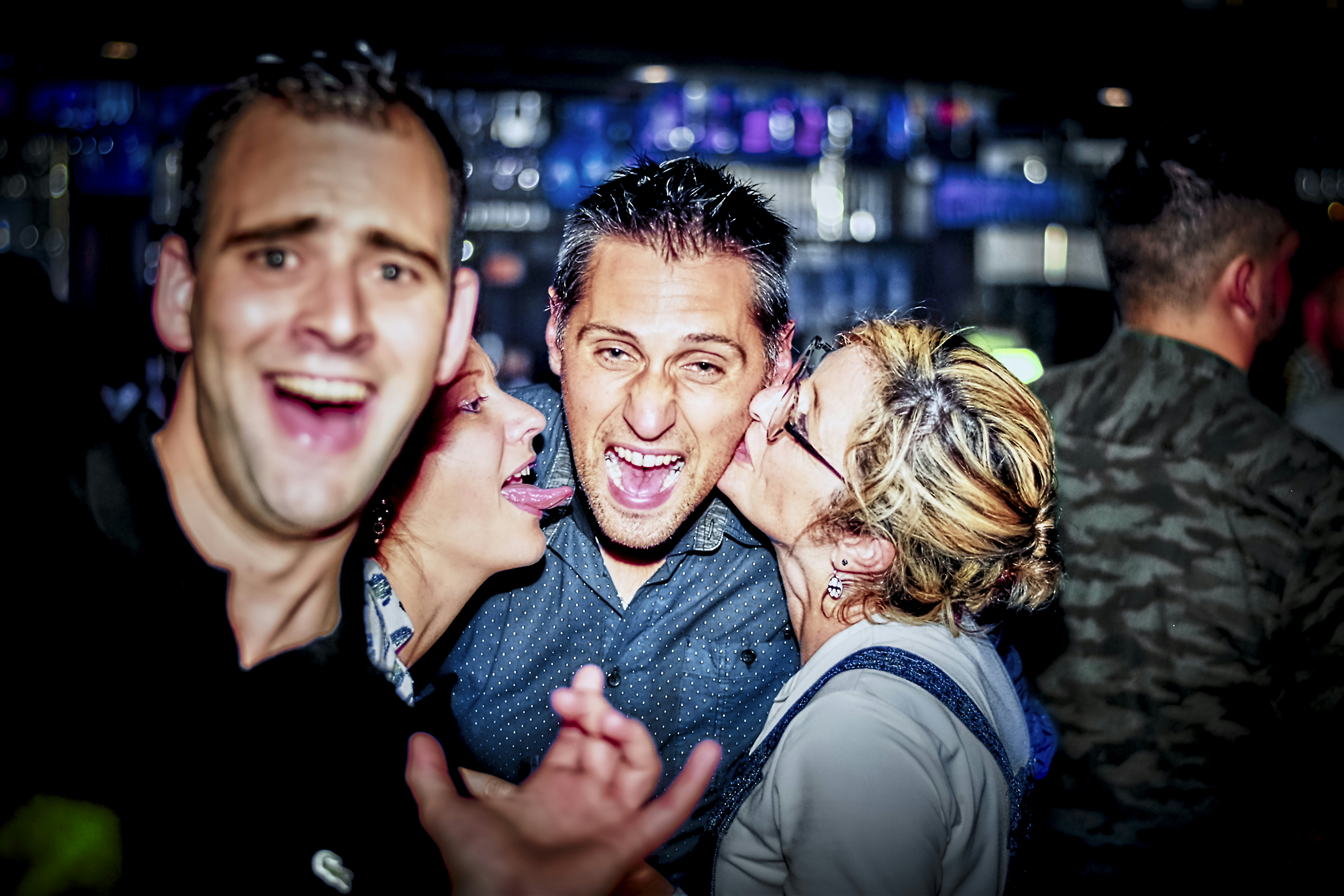 Neon Club Trio: A Spontaneous Kiss Sparks Laughter