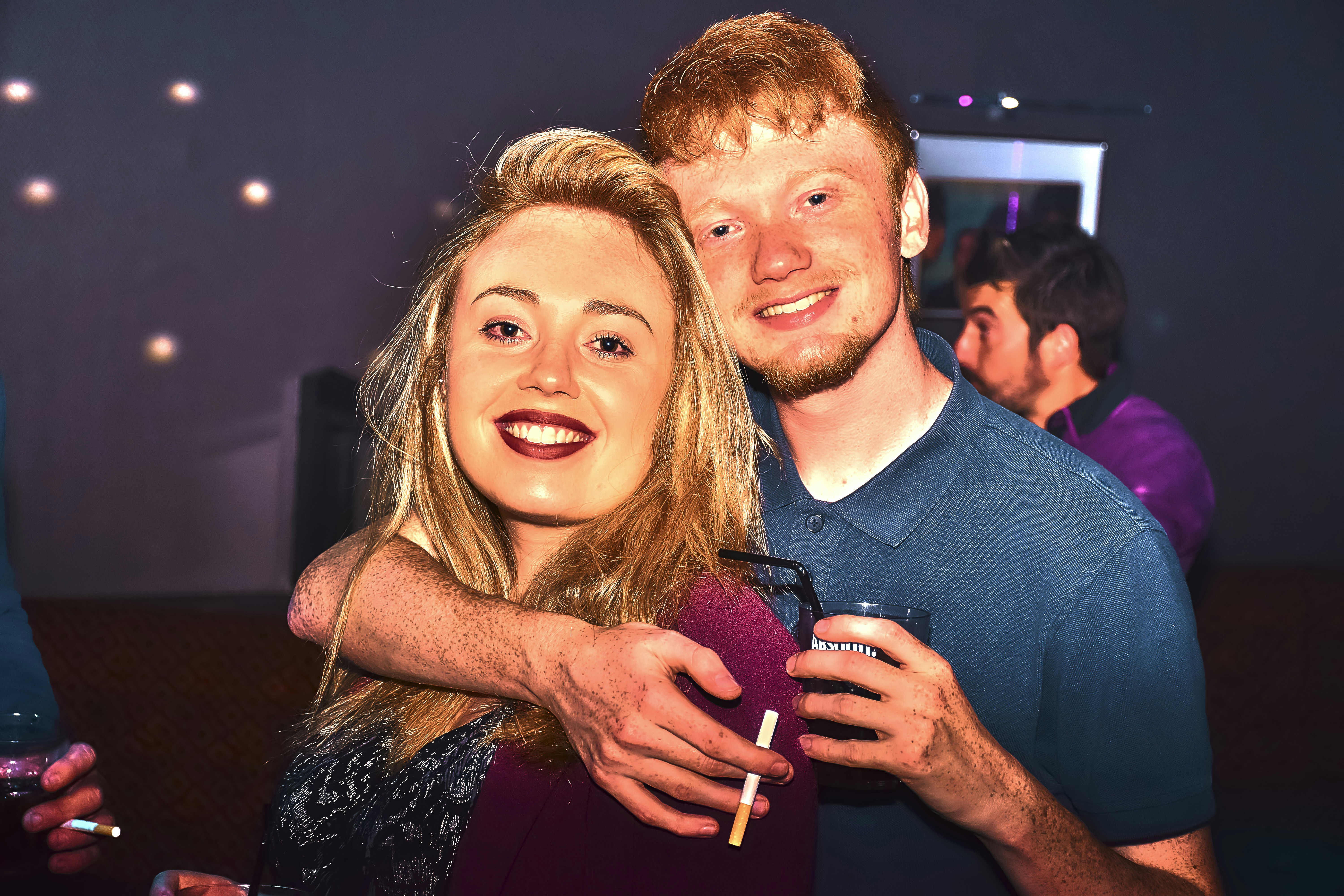 Neon Embrace: A Duo Wrapped in Club Light