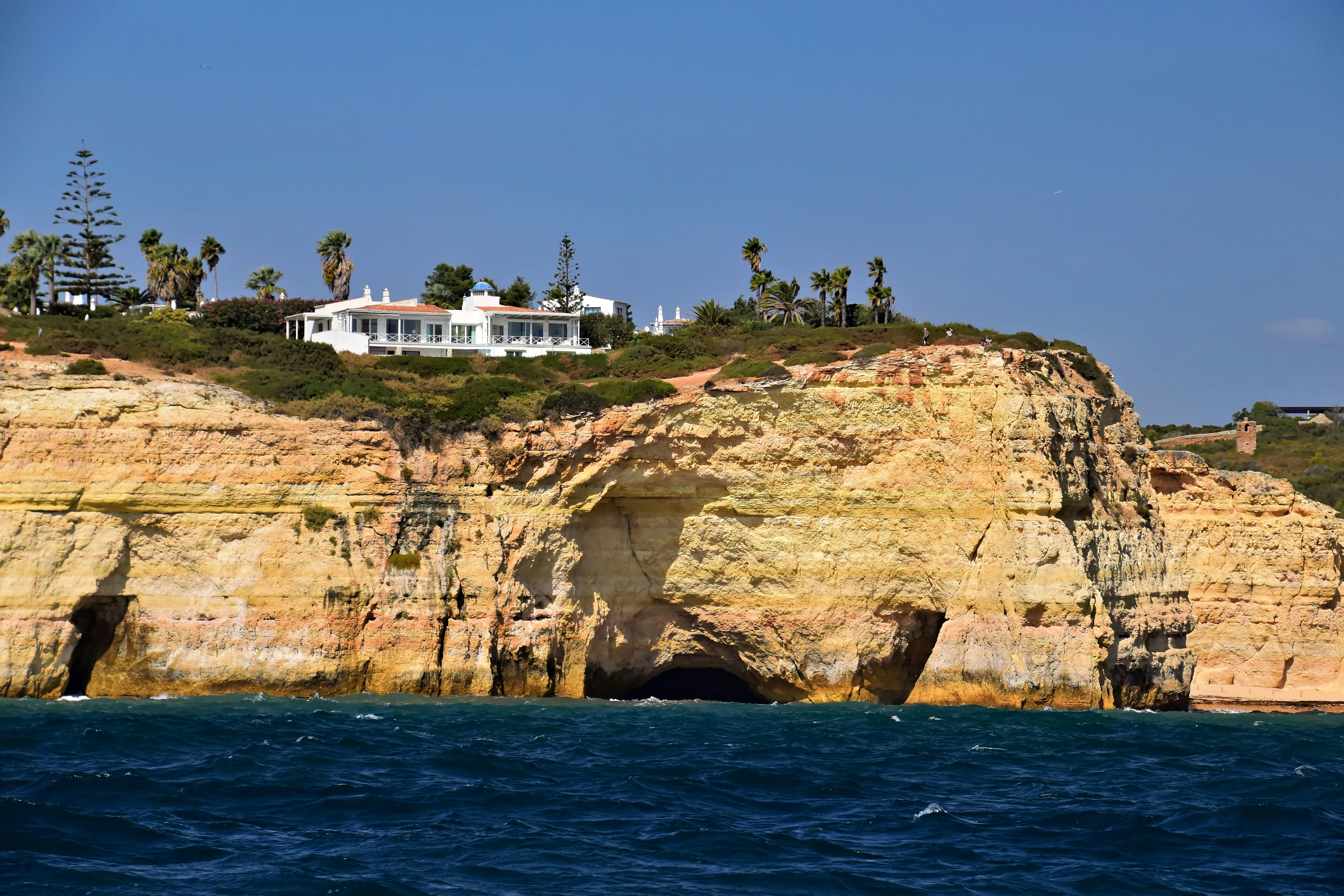Coastal Cliff Estate: White House Overlooking Turquoise Atlantic