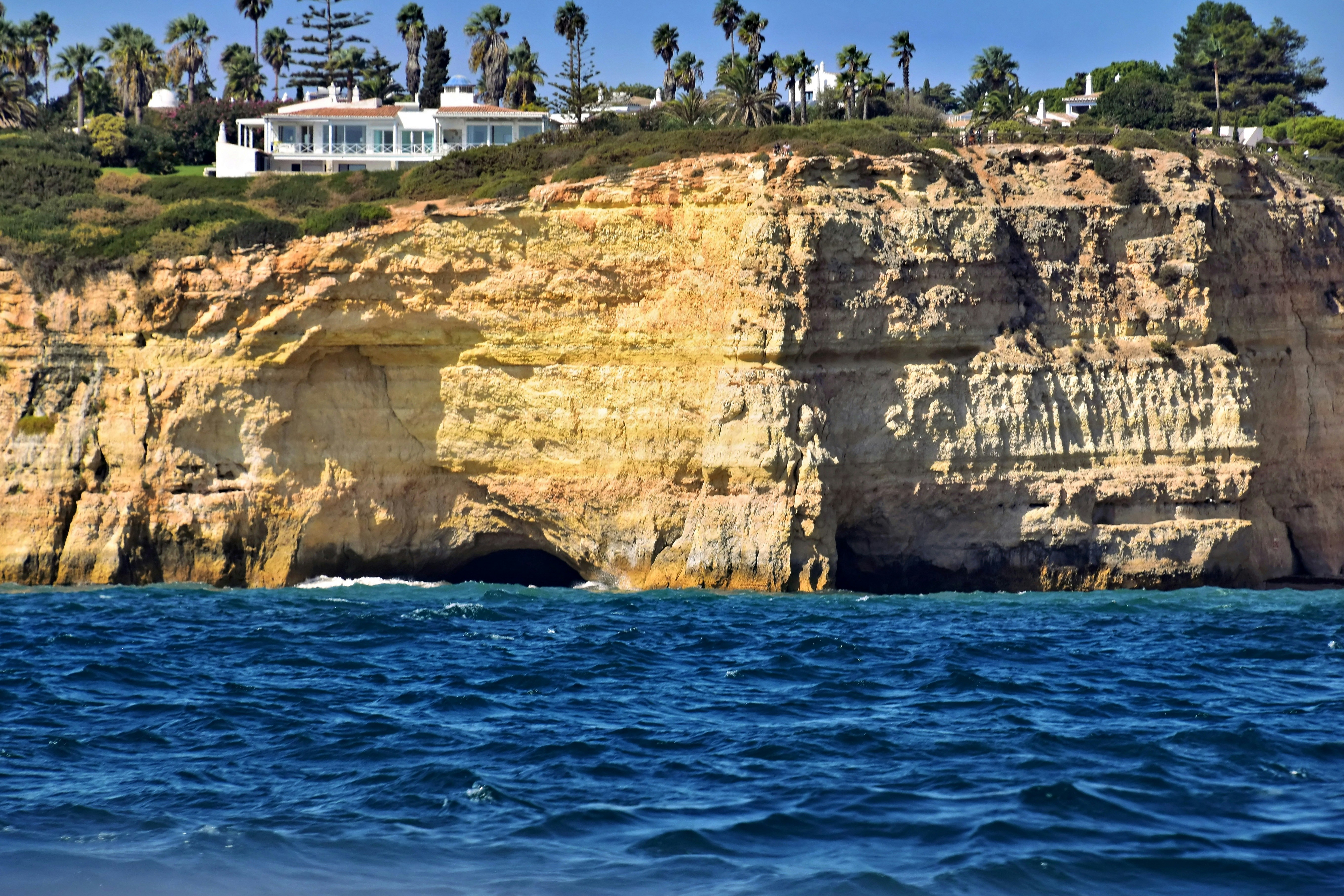Cliffside Retreat: Sunlit Limestone and Sea