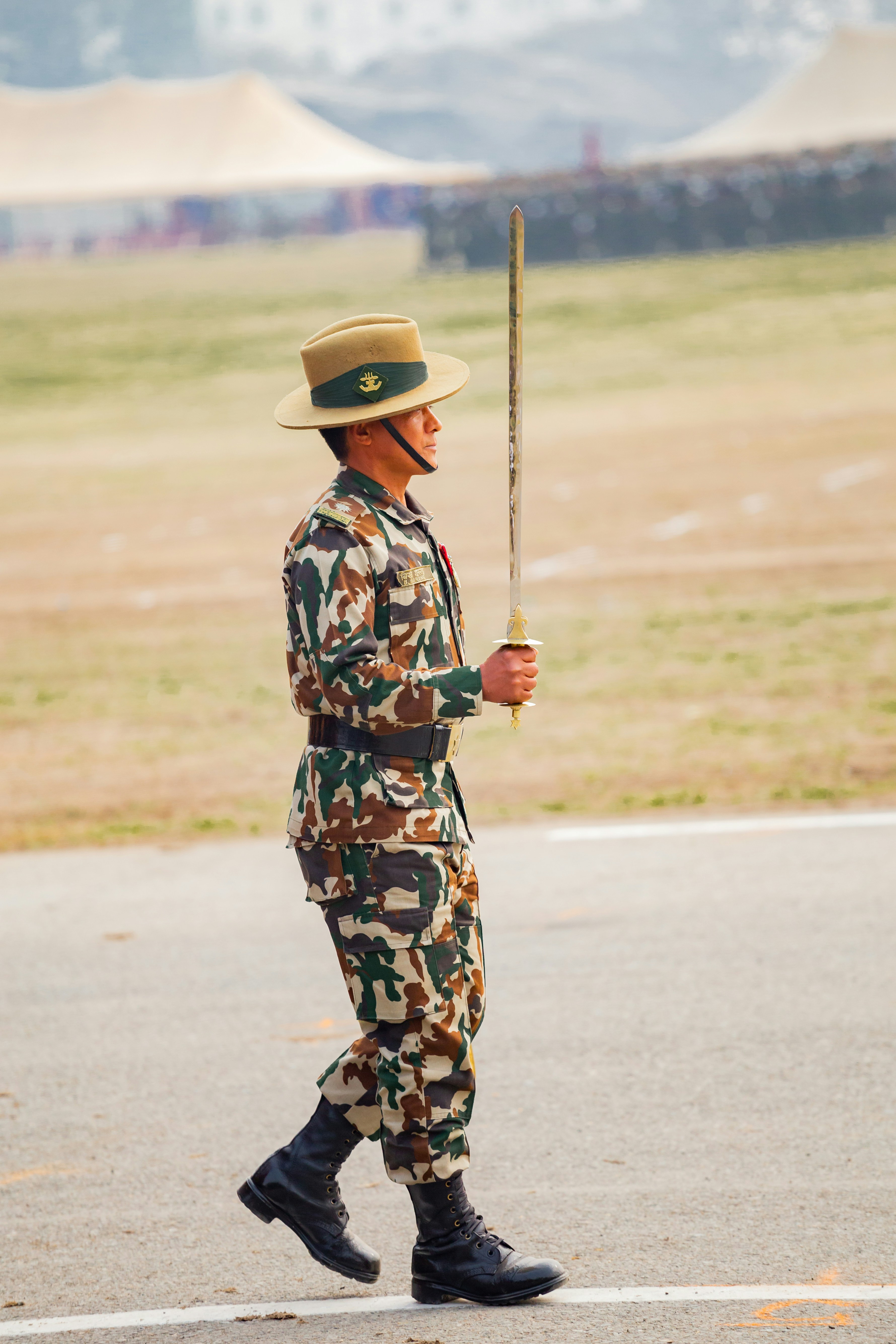 Guard in Camouflage Bearing the Sword of Ceremony
