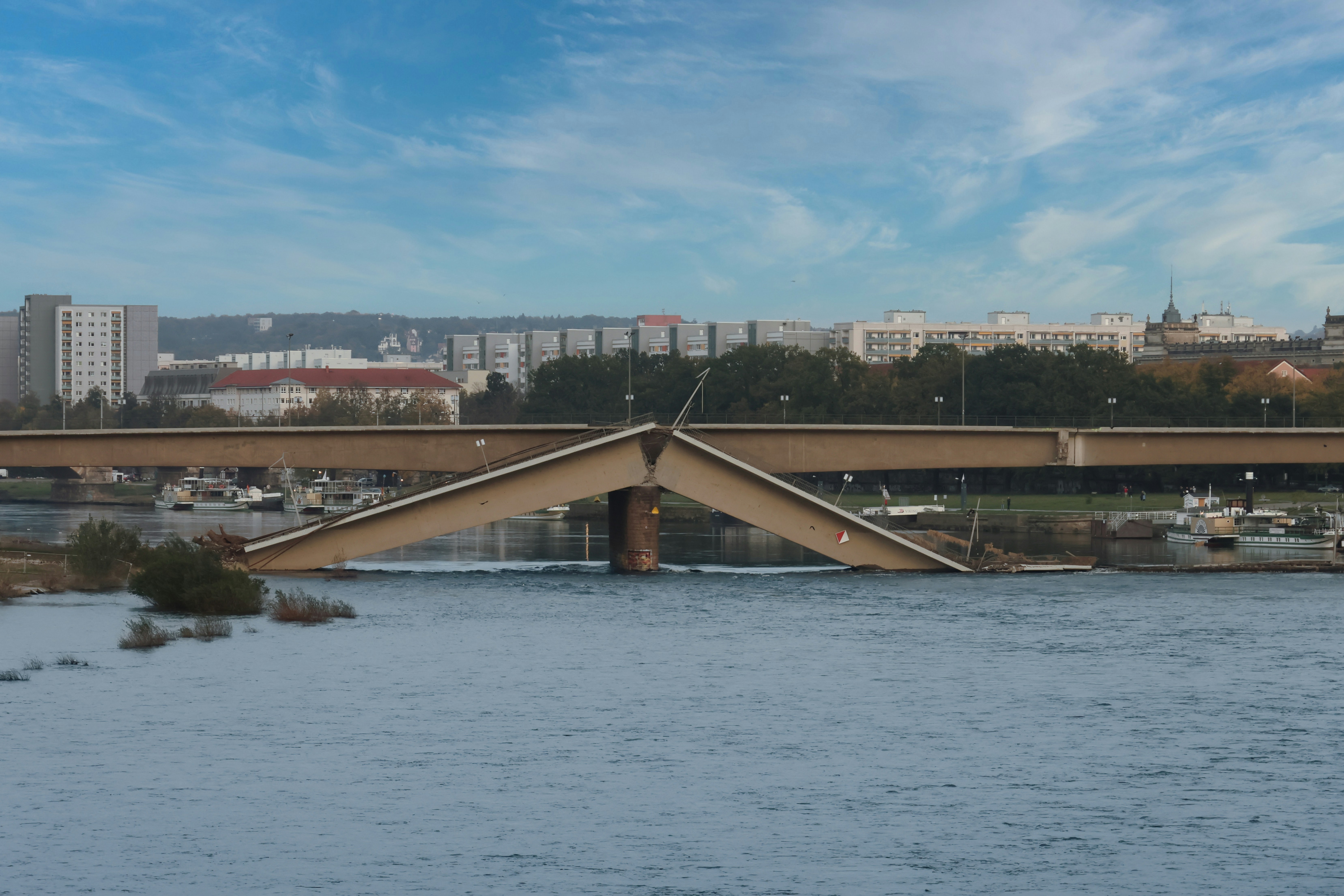 A-Frame Bridge Over a Calm River with a Distant City Horizon