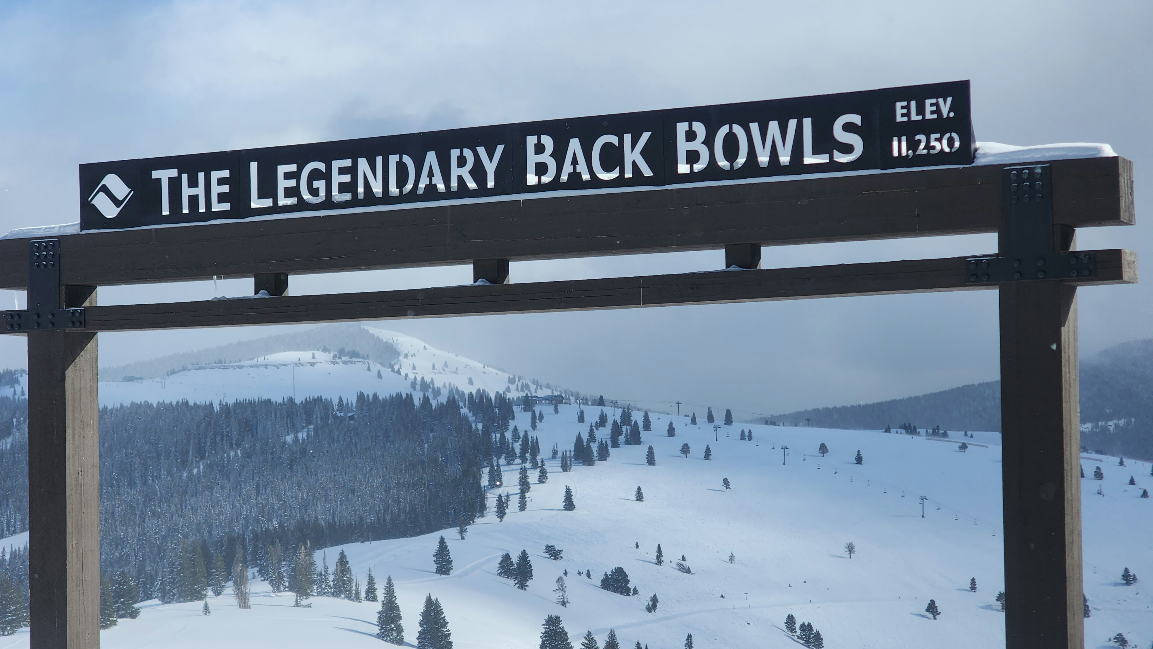 Gateway to the Legendary Back Bowls: Snowy Signpost Over Quiet Alpine Slopes