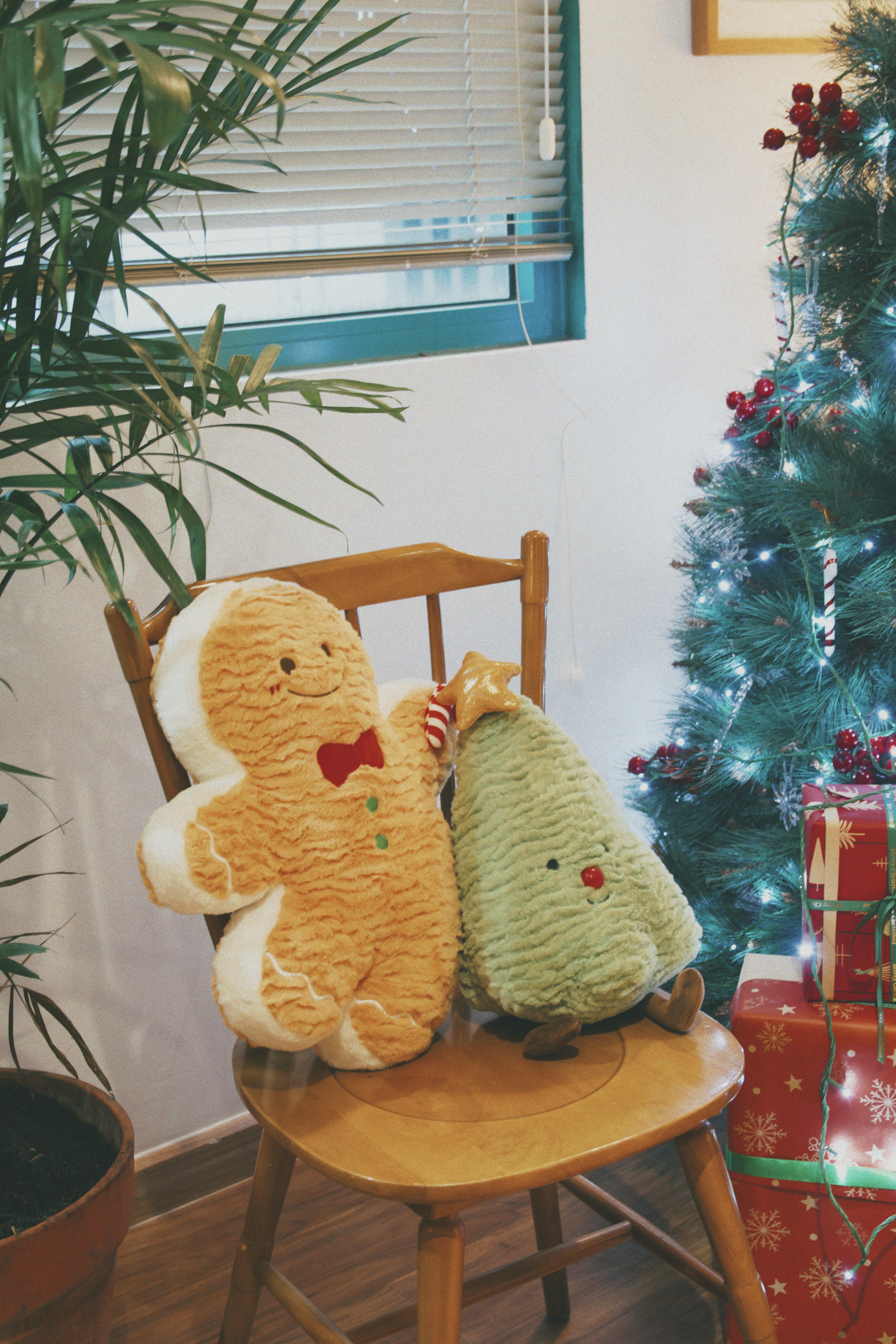 Two Plush Companions Share a Quiet Christmas Moment on a Wooden Chair