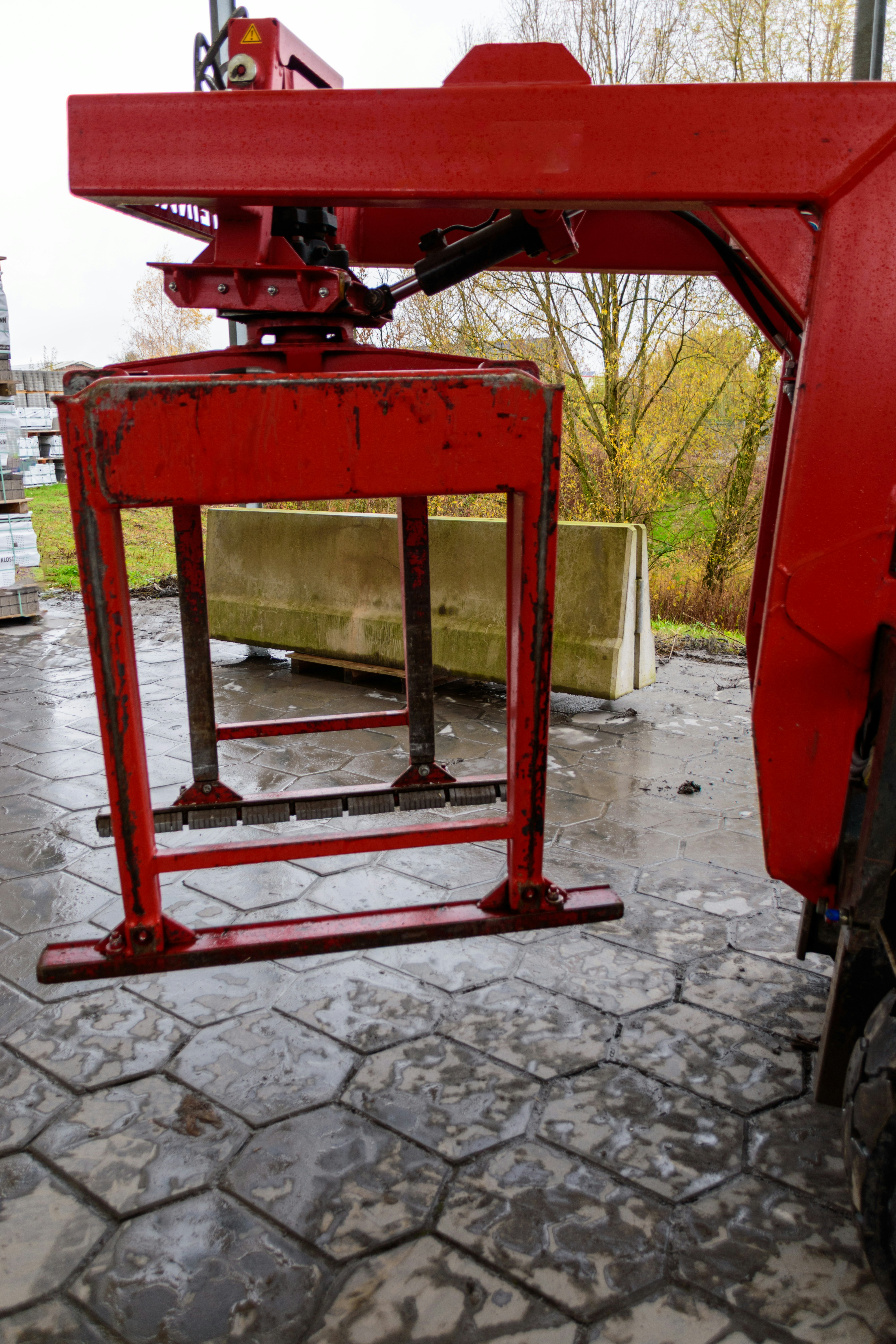 Crimson Frame: Geometry of Industrial Hydraulics in a Wet Outdoor Yard